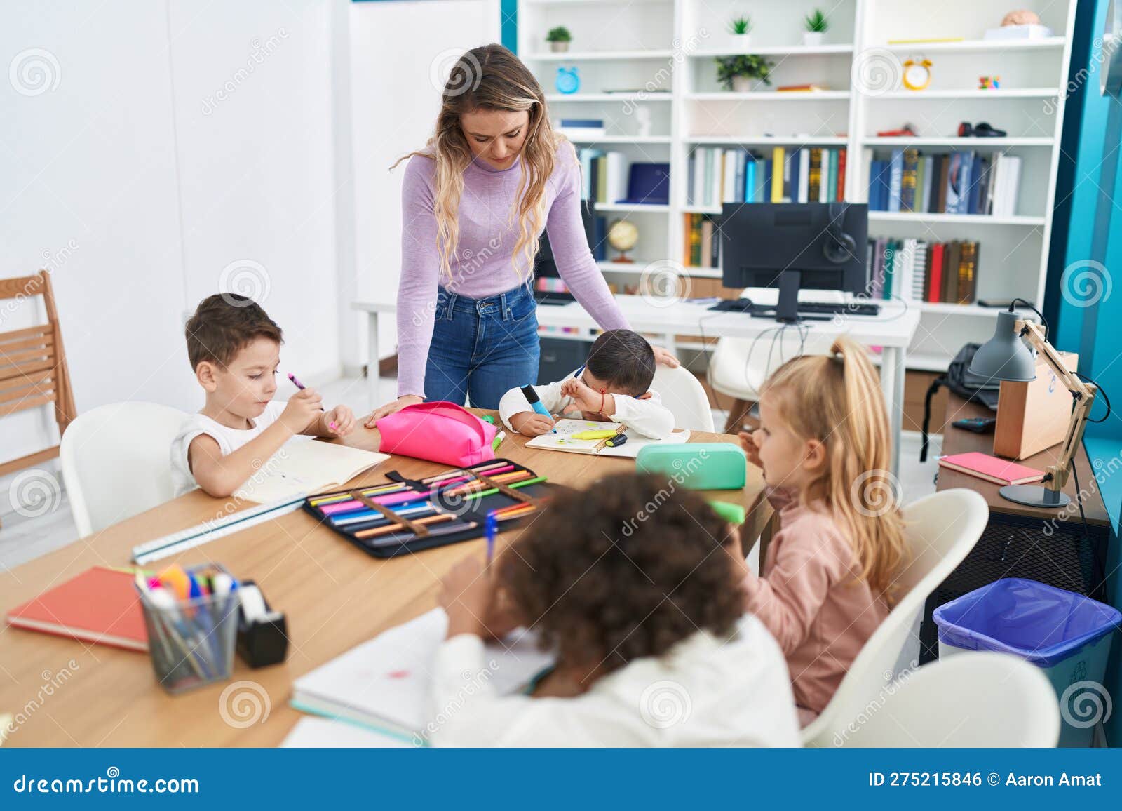 Woman and Group of Kids Having Lesson Sitting on Table at Classroom ...