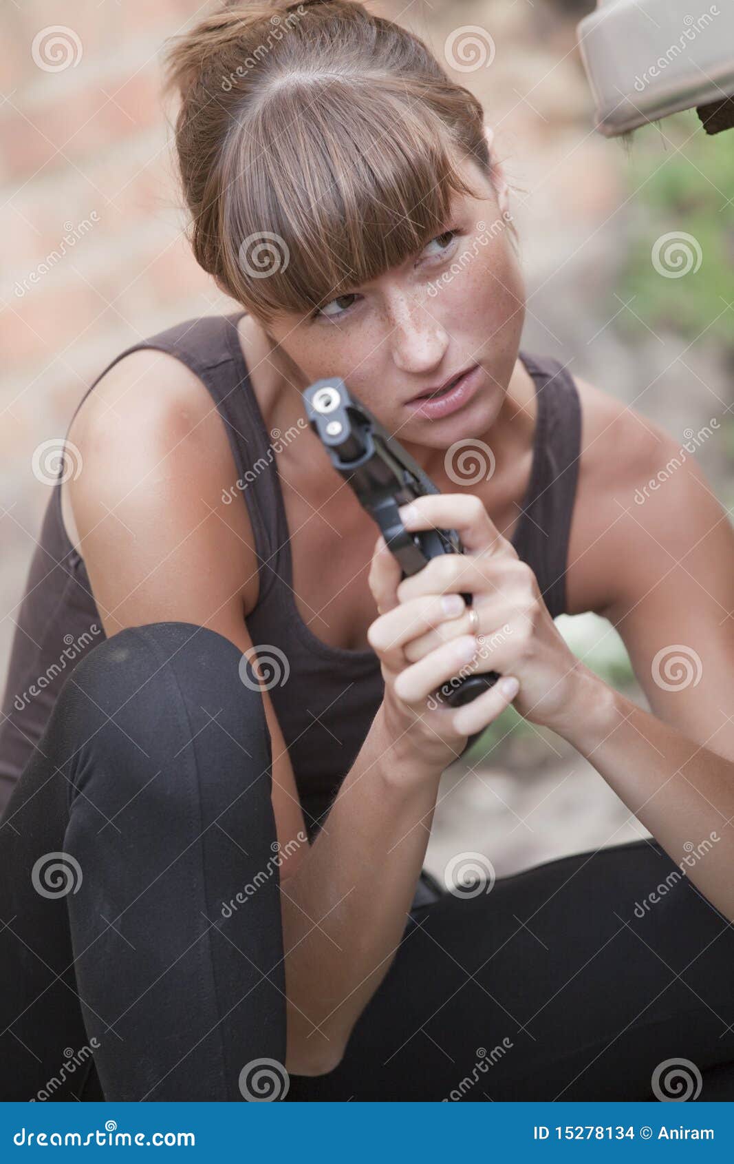 Woman with gun hiding stock photo. Image of protection - 15278134