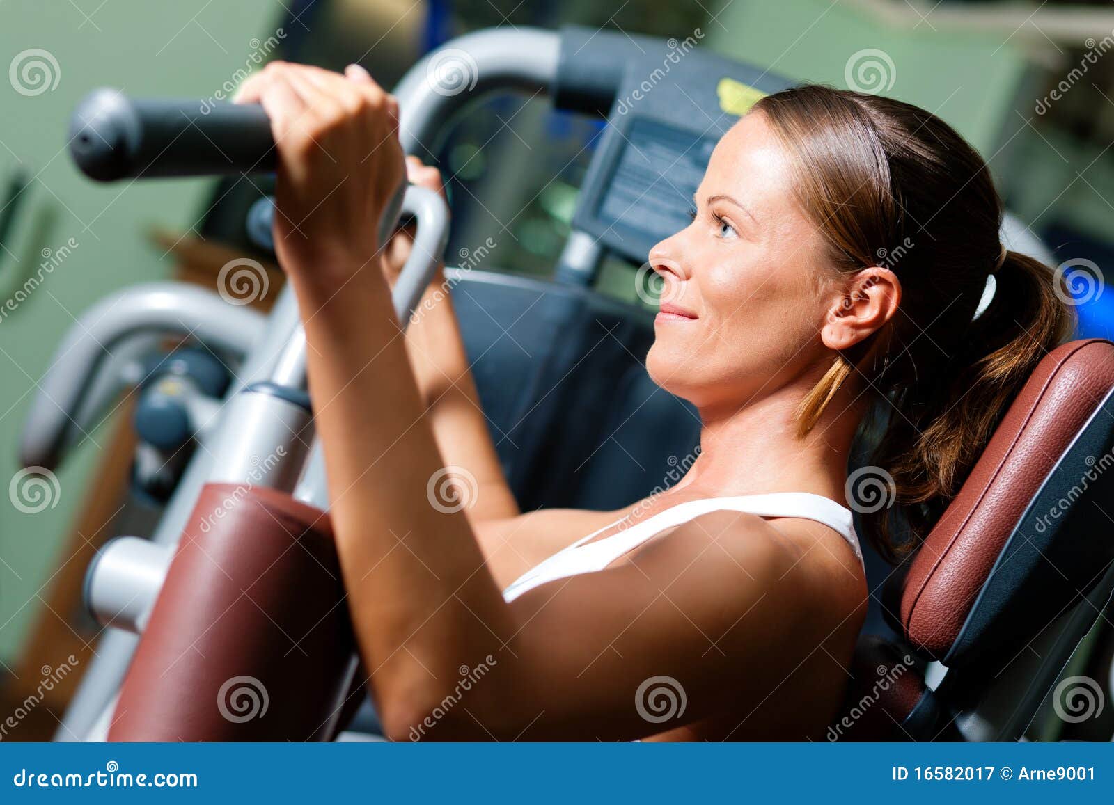 Woman in Gym on Machine Exercising Stock Image - Image of powerful ...