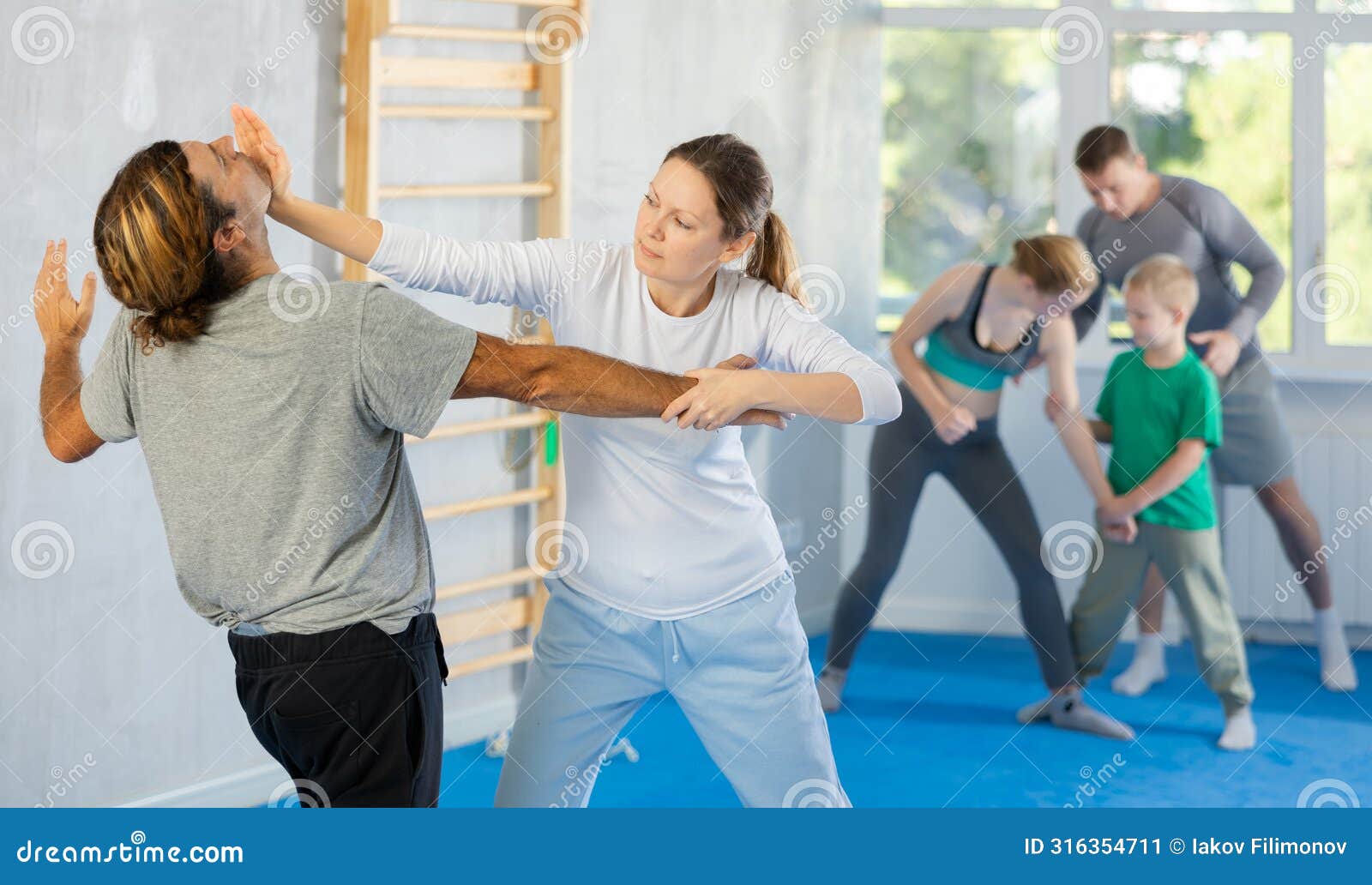 Woman in Gym Perform Basic Elements of Krav Maga Self-defense System ...