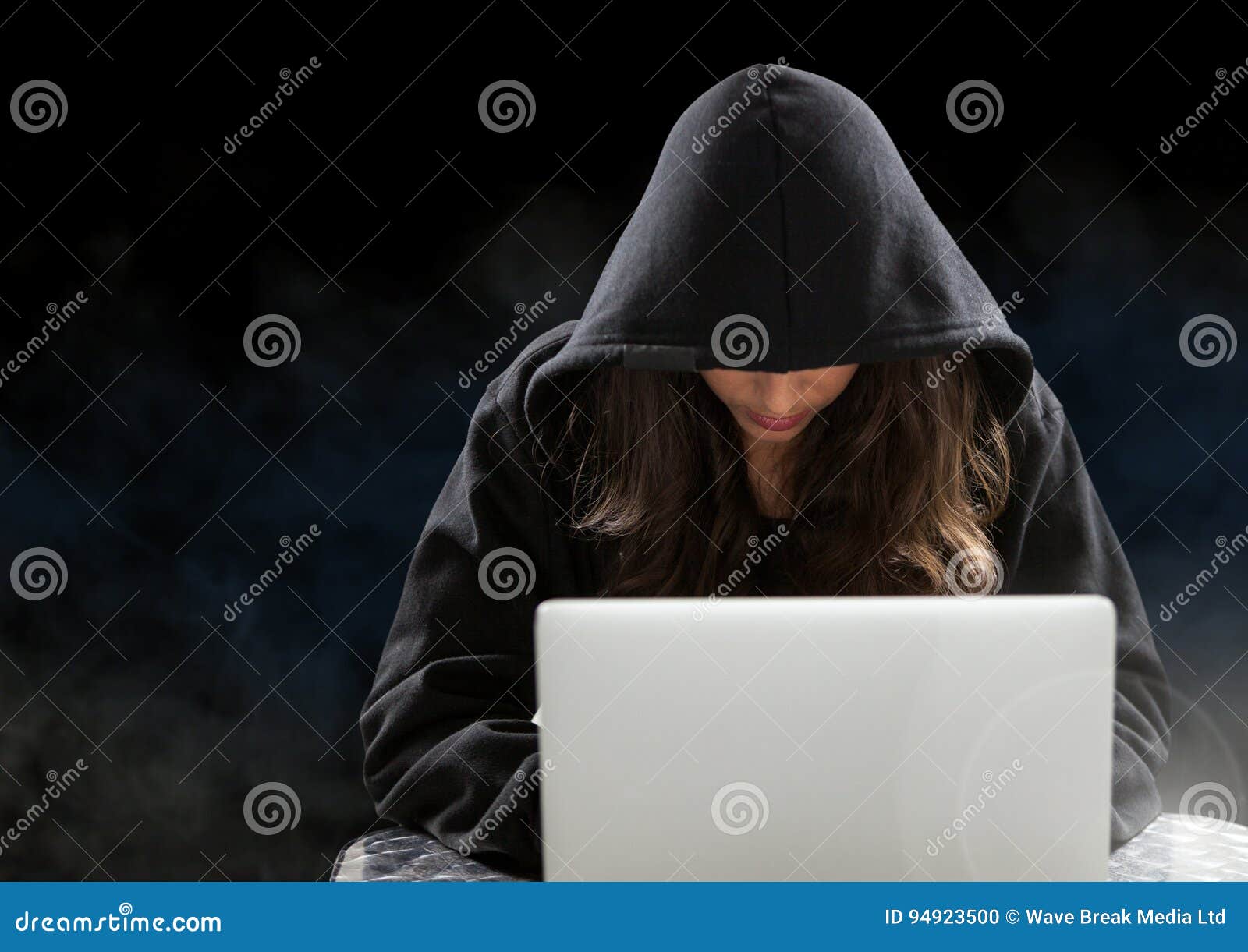 Woman Hacker Working on Laptop in Front of Black Background Stock Photo ...