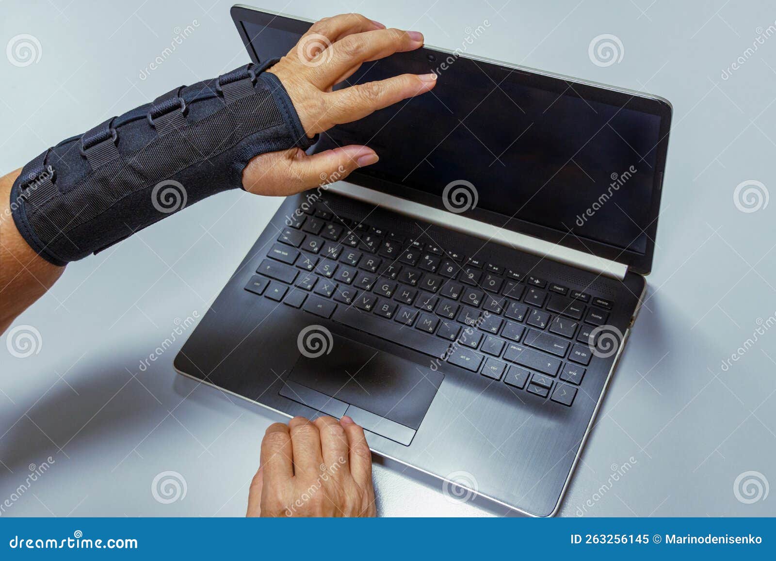 Woman Hand in Black Orthosis is Closes Computer after Work Stock Image ...