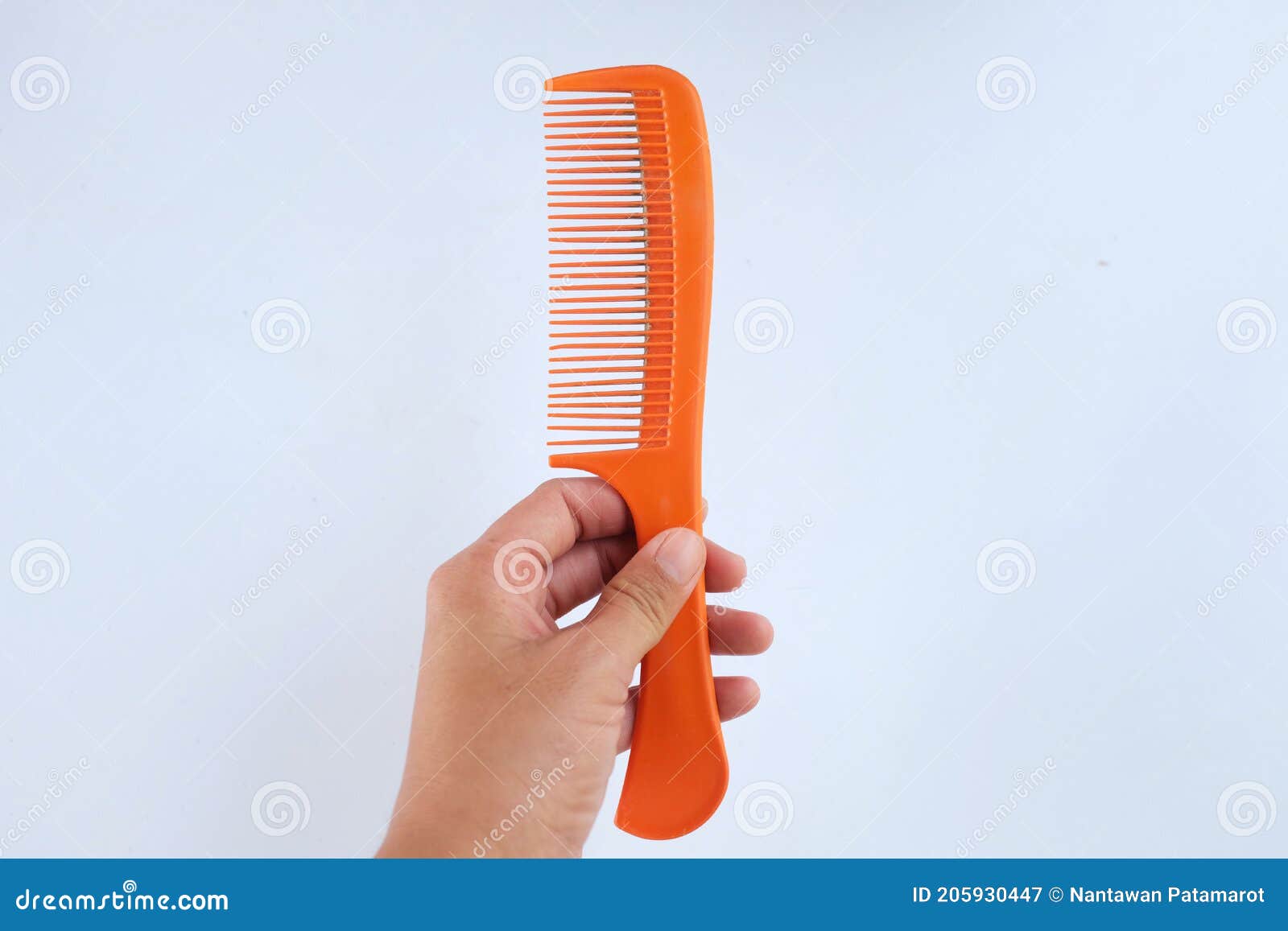 Woman Hand Holding Orange Comb Isolate on a White Background. Stock ...
