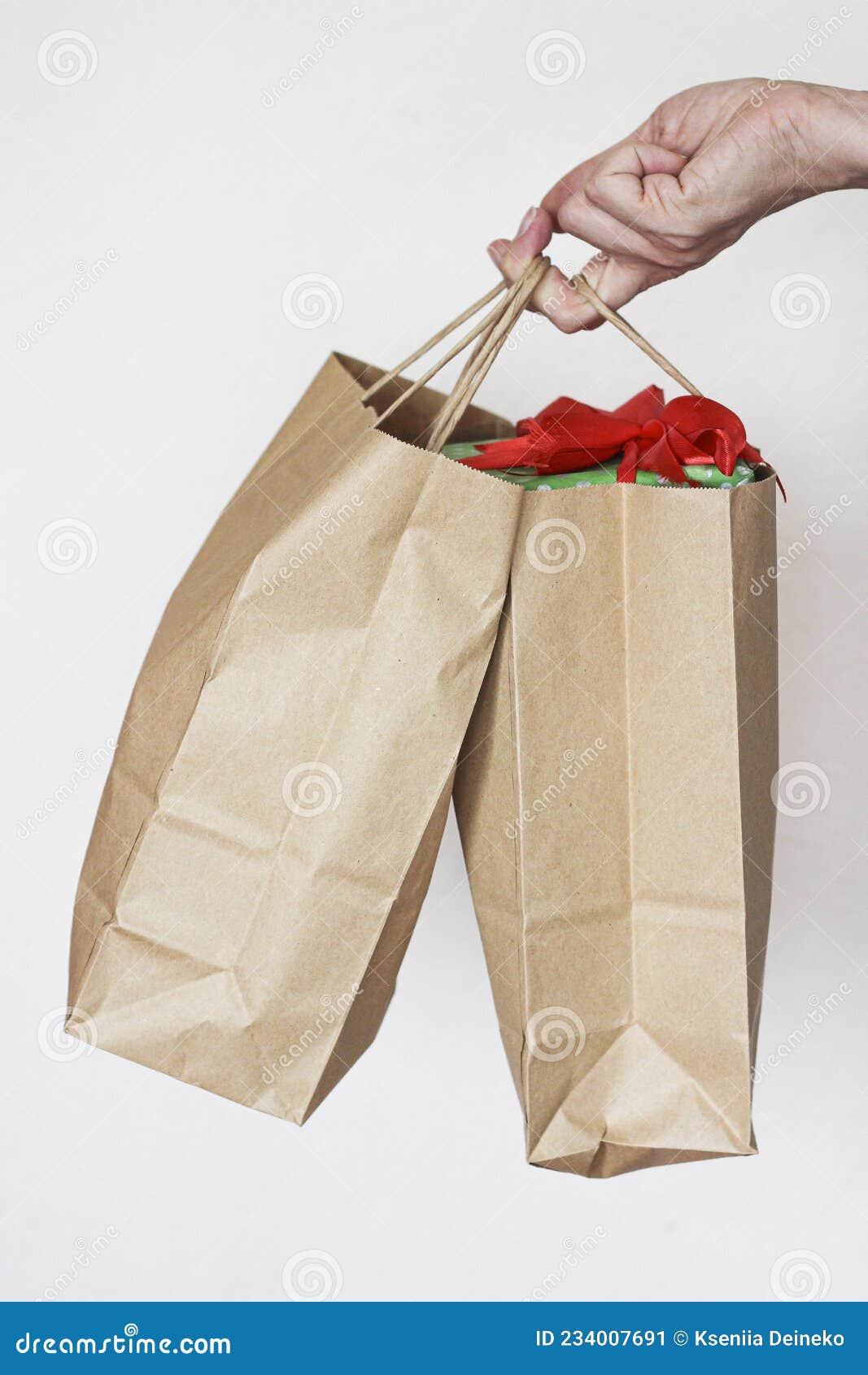 Woman Hand Holding Packet with Gift Boxes Stock Image - Image of kraft ...