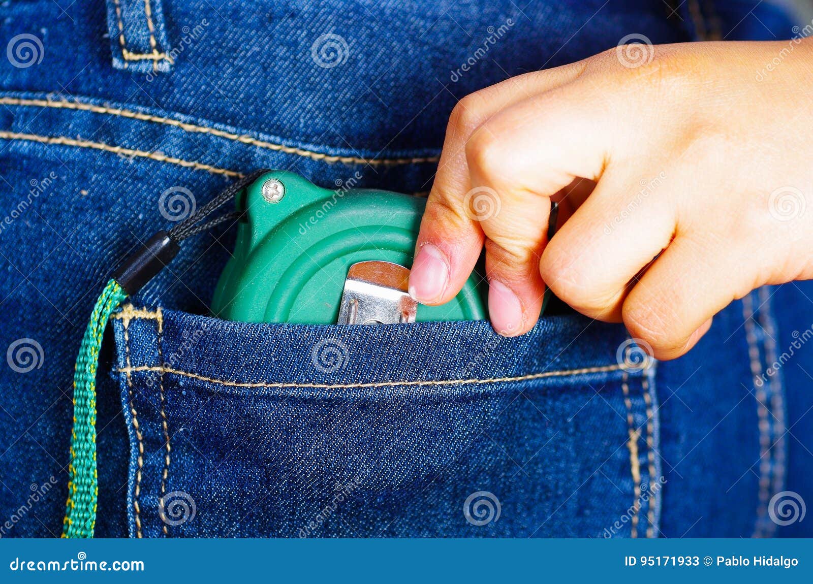 Woman Hand Introducing a Measuring Tape Inside of Jeans Back Pocket ...