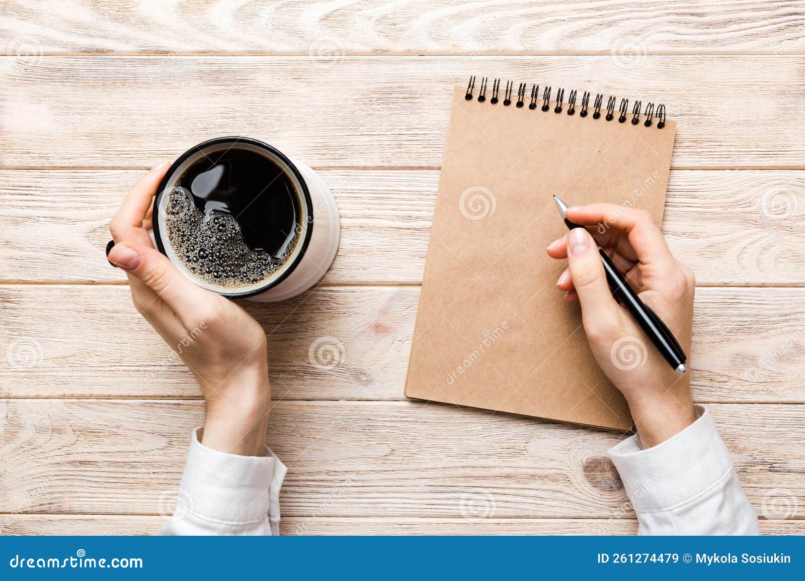 Woman Hand with Pencil Writing on Notebook and Hold Coffee Cup. Woman ...