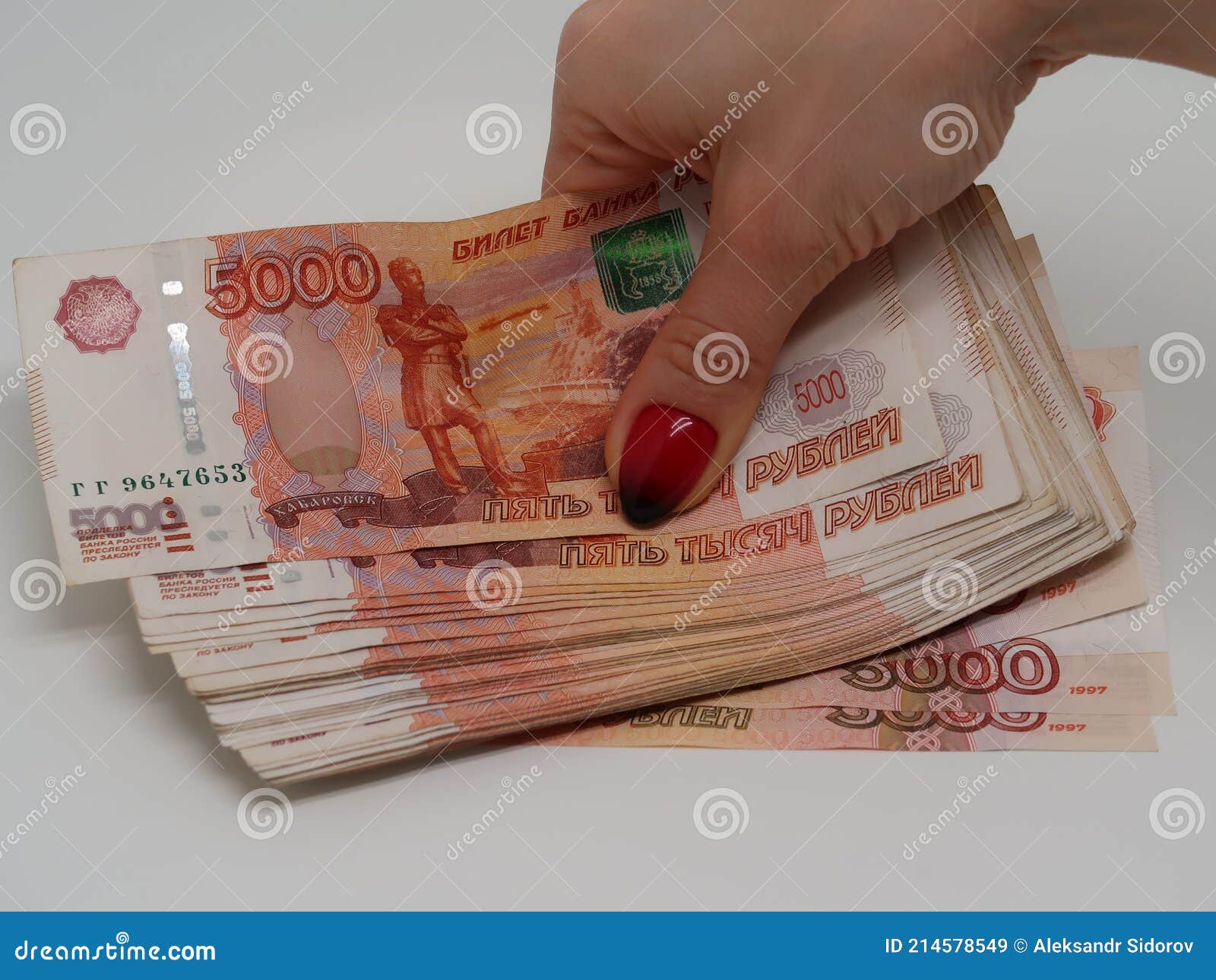 A Woman Hand Puts a Bundle of Five-thousandth Banknotes on the Surface ...