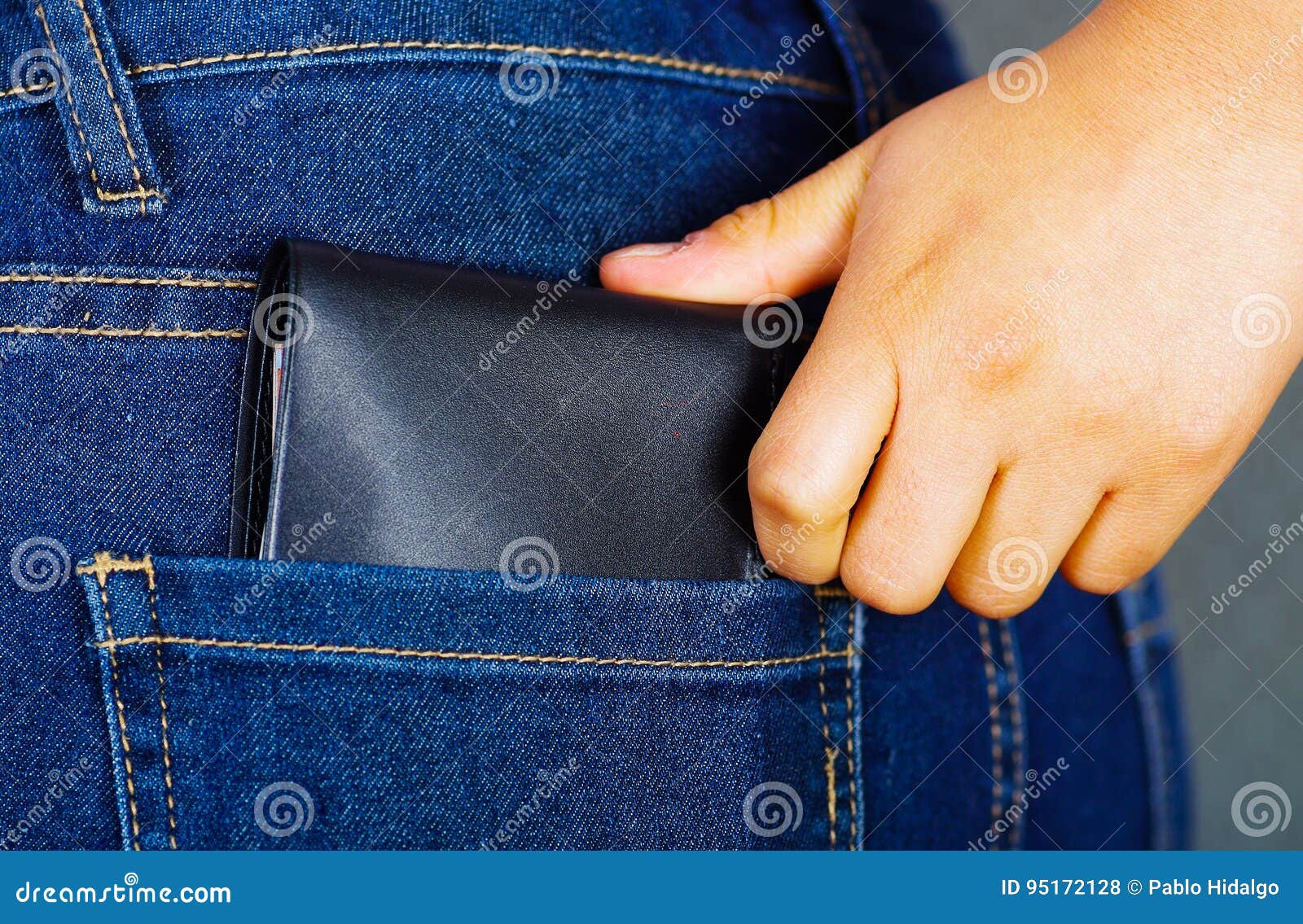 Woman Hand Putting a Black Wallet Inside of Jeans Back Pocket Stock ...