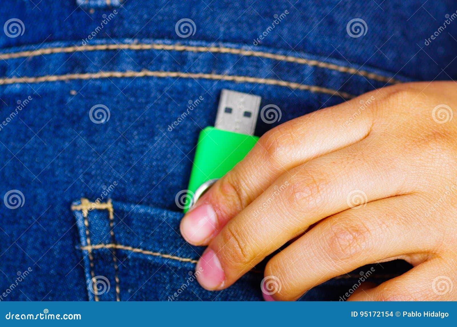 Woman Hand Putting a Green Flash Memory Inside of Jeans Back Pocket ...