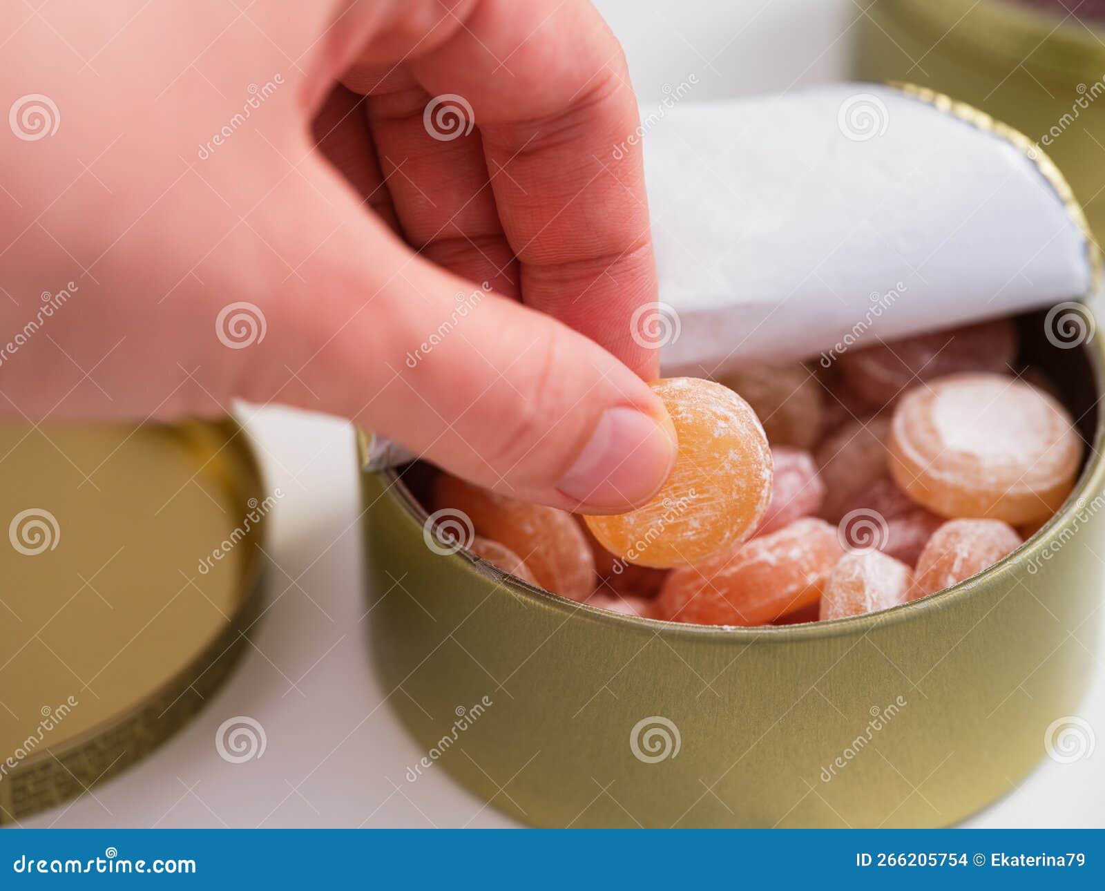 Woman Hand Taking a Candy from a Tin Box Full of Fruit Drops Candies ...