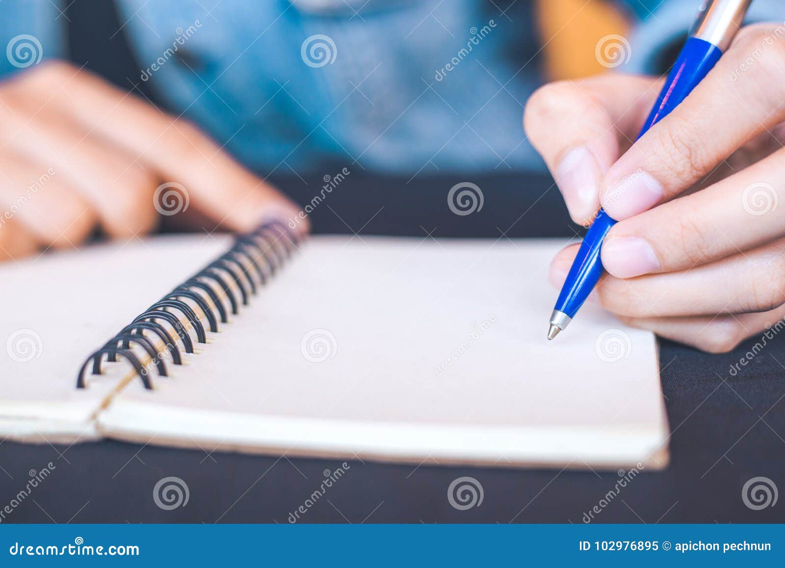 Woman Hand is Writing on a Note Pad with a Pen in the Office. Stock ...