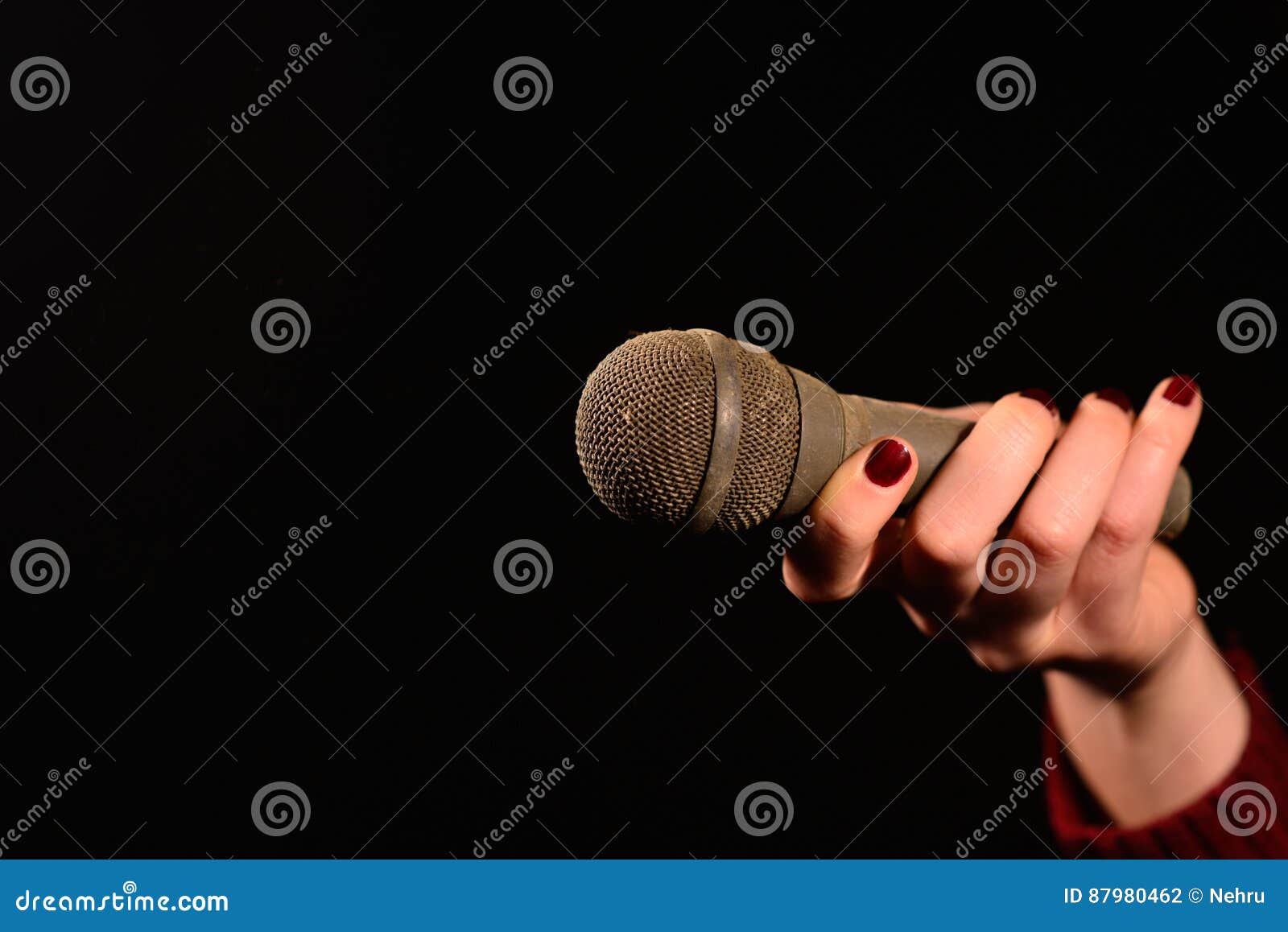 Woman Hands Holding Dirty and Dusty Microphone on a Dark Background ...