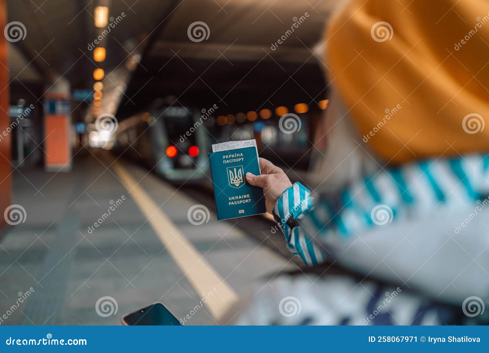 Woman Hands With Ukrainian Biometric Passport At Trip Train Station