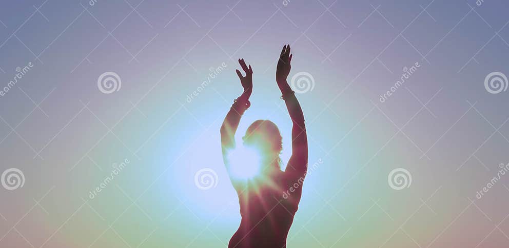 Woman With Hands Up In The Air Illuminated With Sunlight Dancing