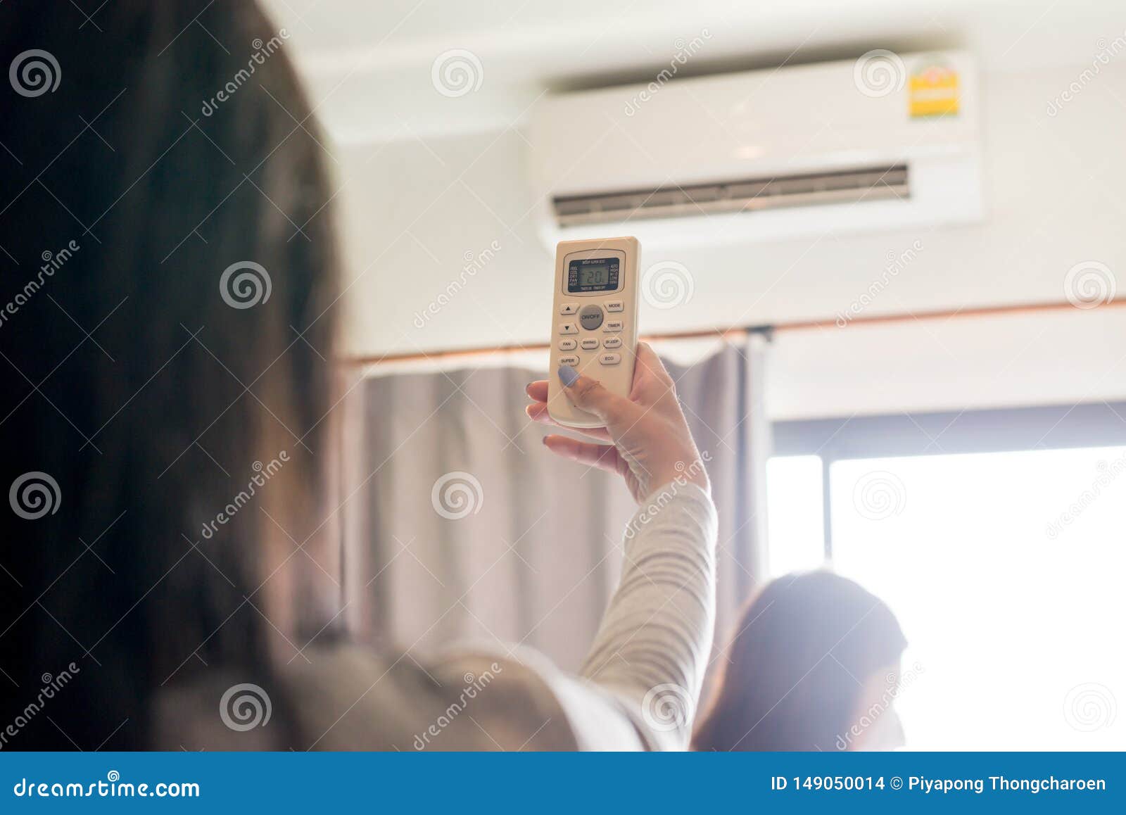 Woman Hands Using on a Remote Control To Activating Air Conditioning ...