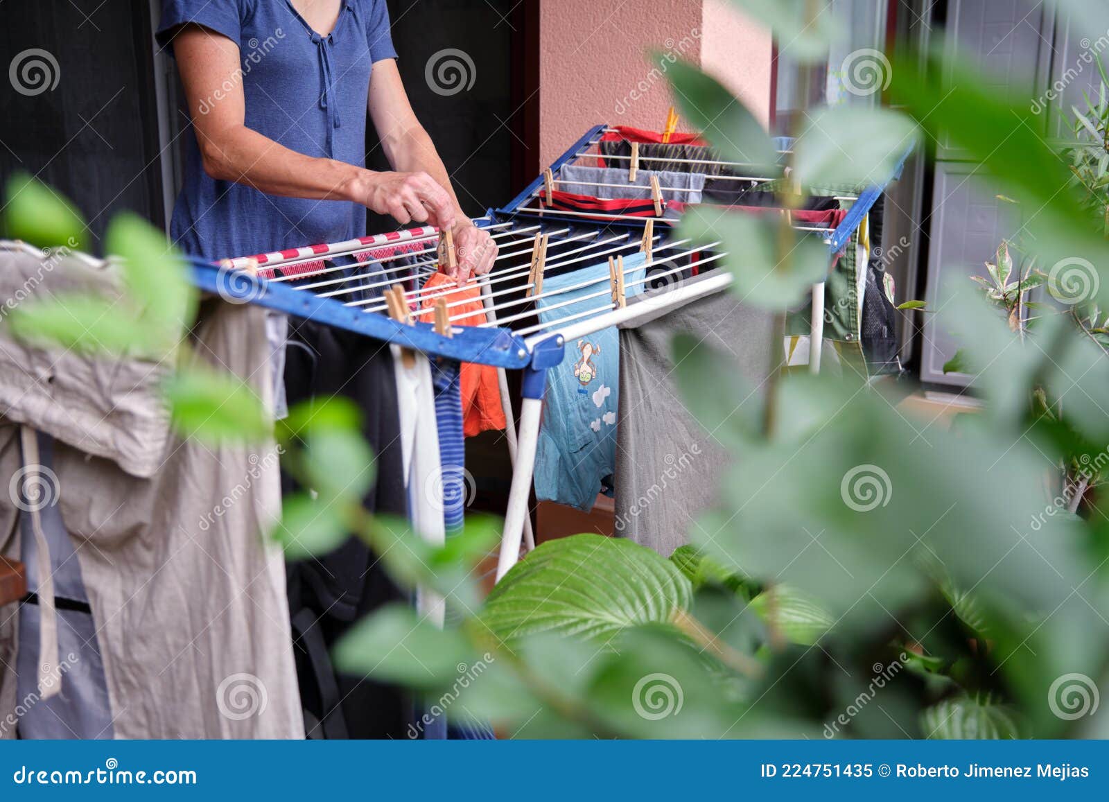 Woman Hanging Clothes on the Balcony Stock Image - Image of person ...