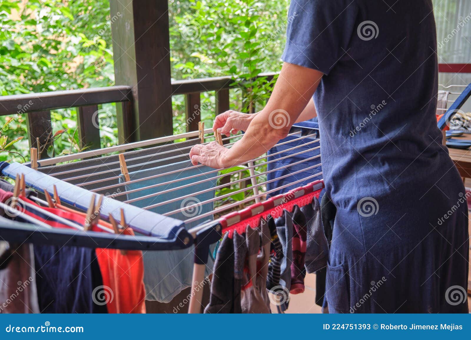 Woman Hanging Clothes on the Balcony Stock Image - Image of hanging ...