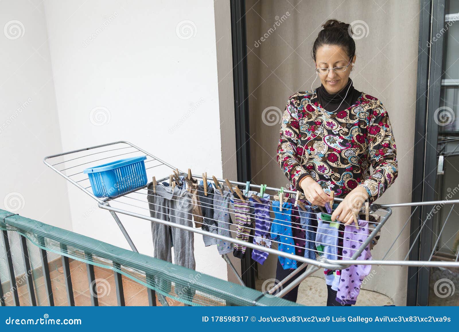 Woman hanging clothes stock image. Image of housekeeping - 178598317
