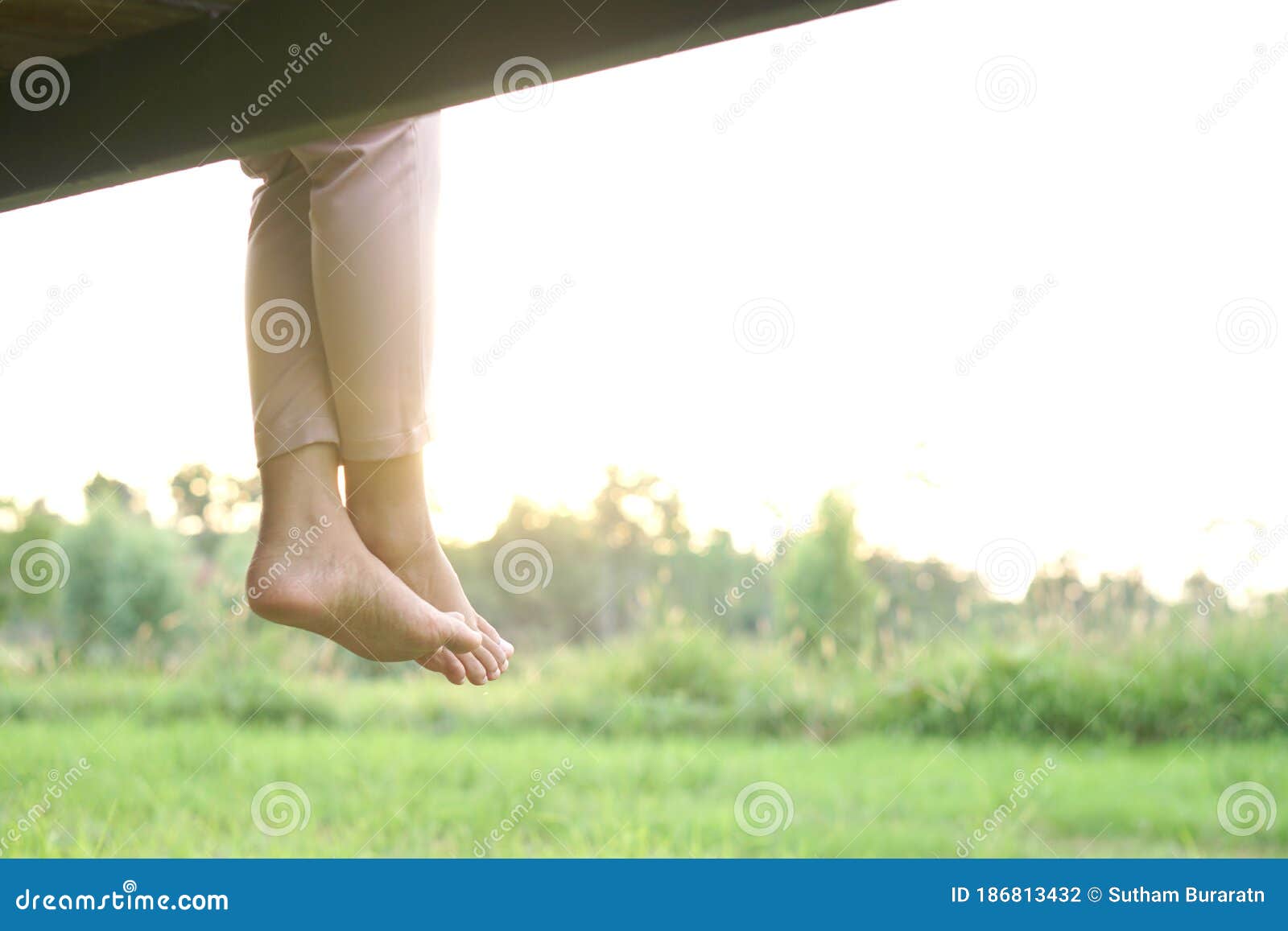 Woman Hanging Her Feet from Bridge Stock Photo - Image of bridge, feet ...