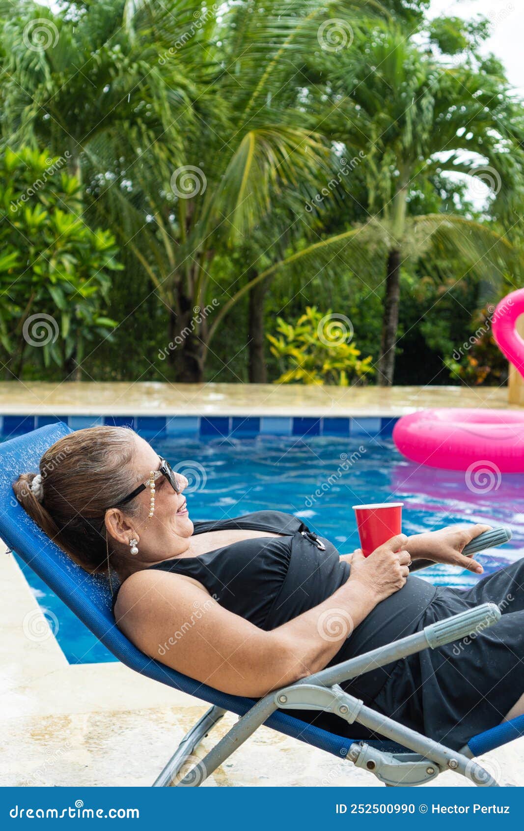 Woman hanging out by pool stock photo. Image of party - 252500990
