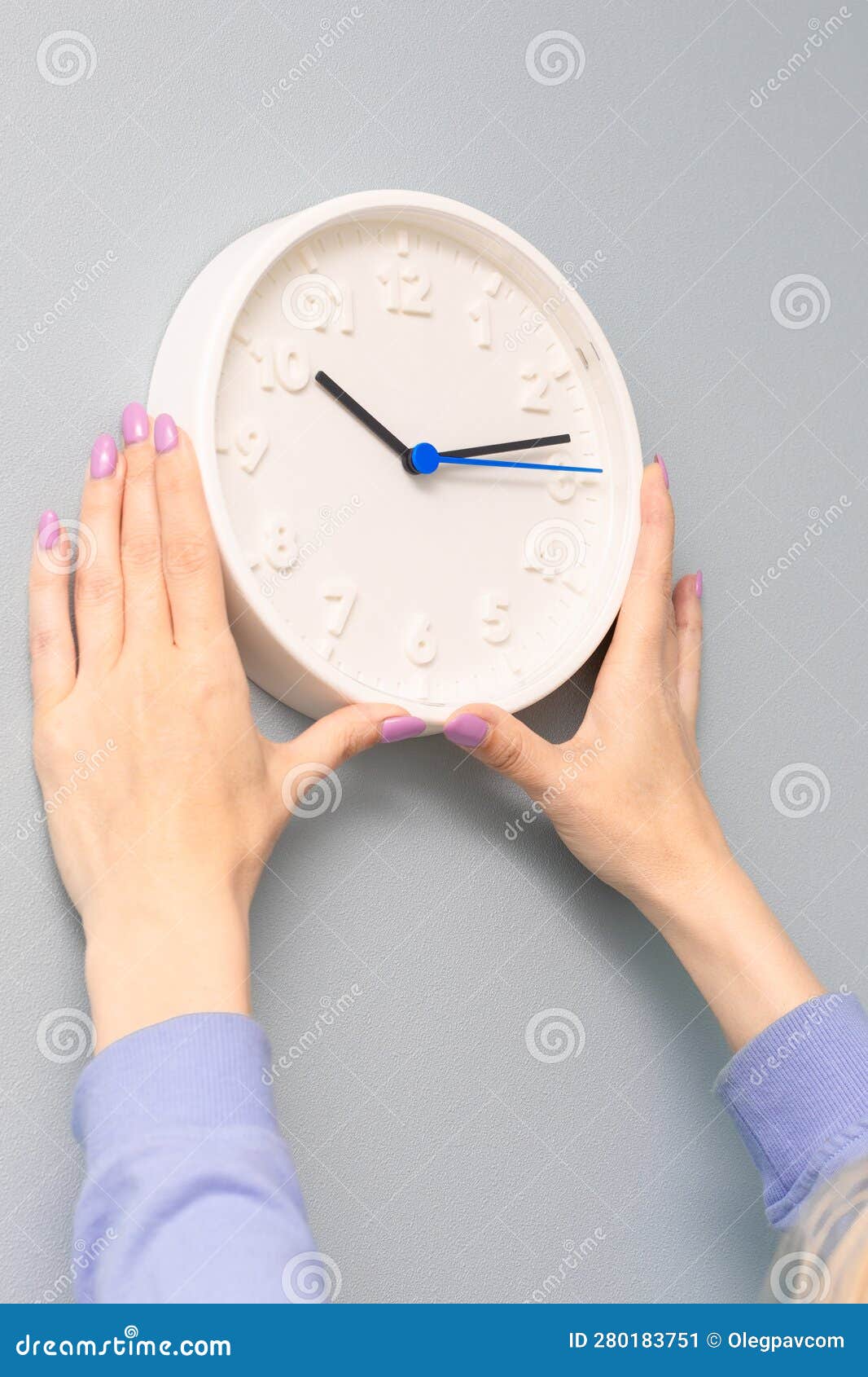 Woman Hangs a Clock on the Wall of the Room. Stock Image - Image of ...