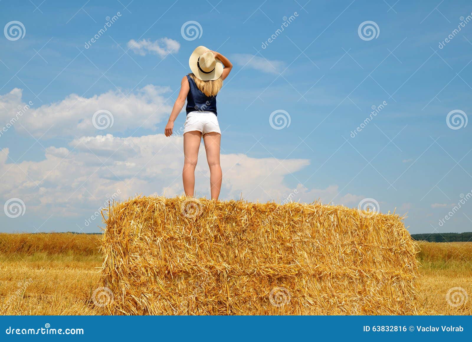 Woman with Hat Standing on a Bale of Straw Stock Photo - Image of ...
