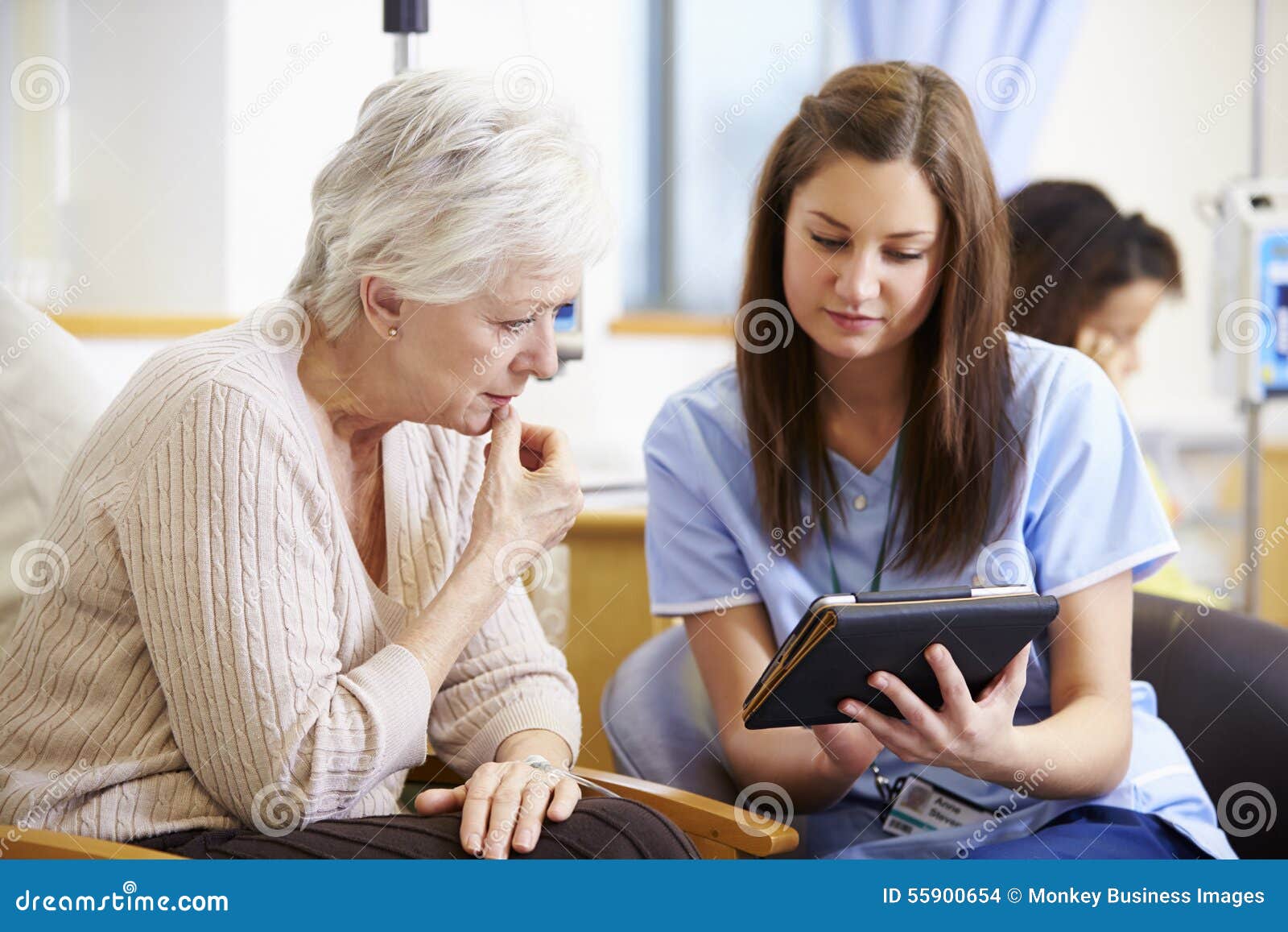 Woman Having Chemotherapy with Nurse Using Digital Tablet Stock Photo ...