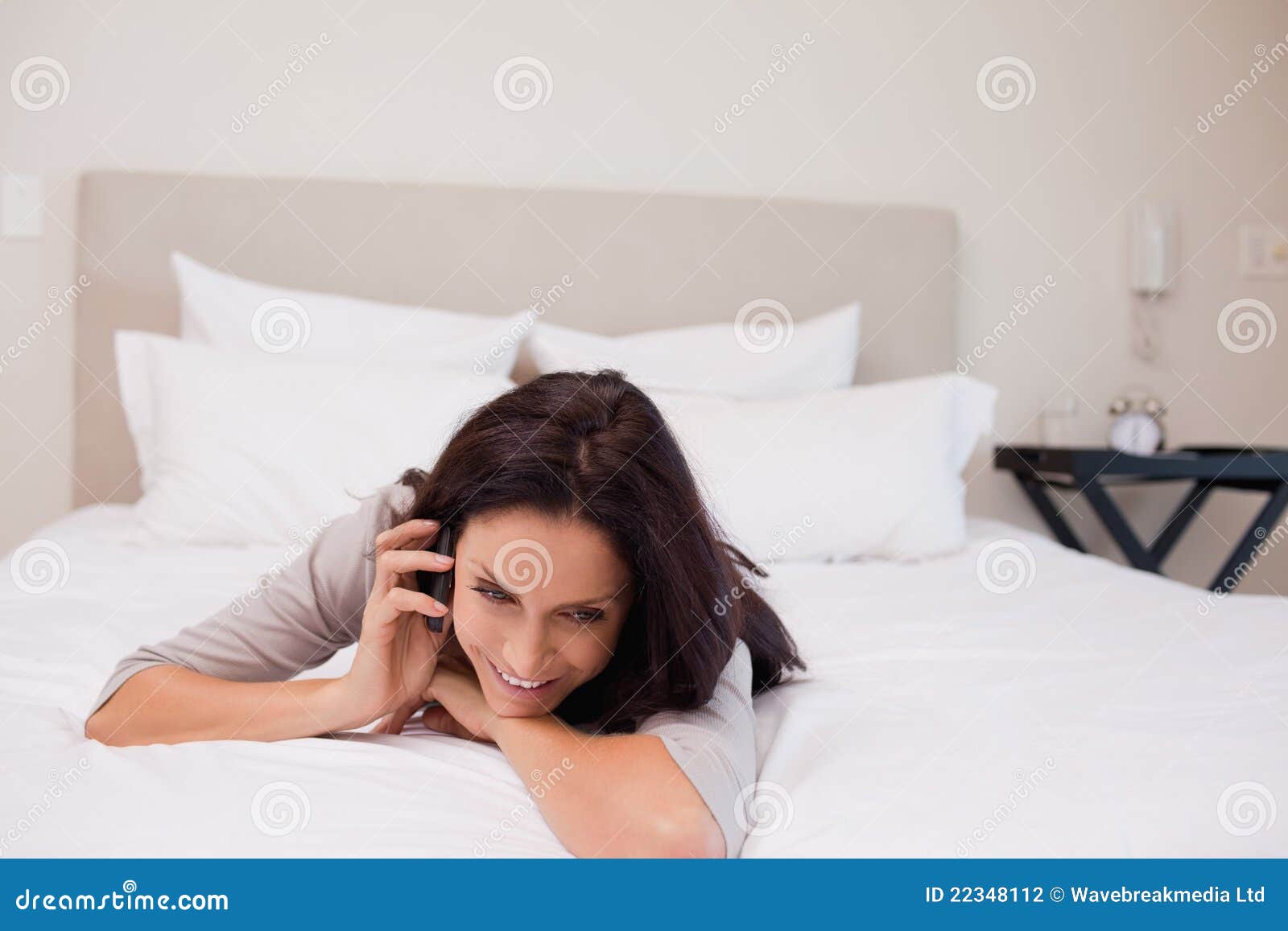 Woman Having a Joyful Phone Call on Her Bed Stock Photo - Image of ...