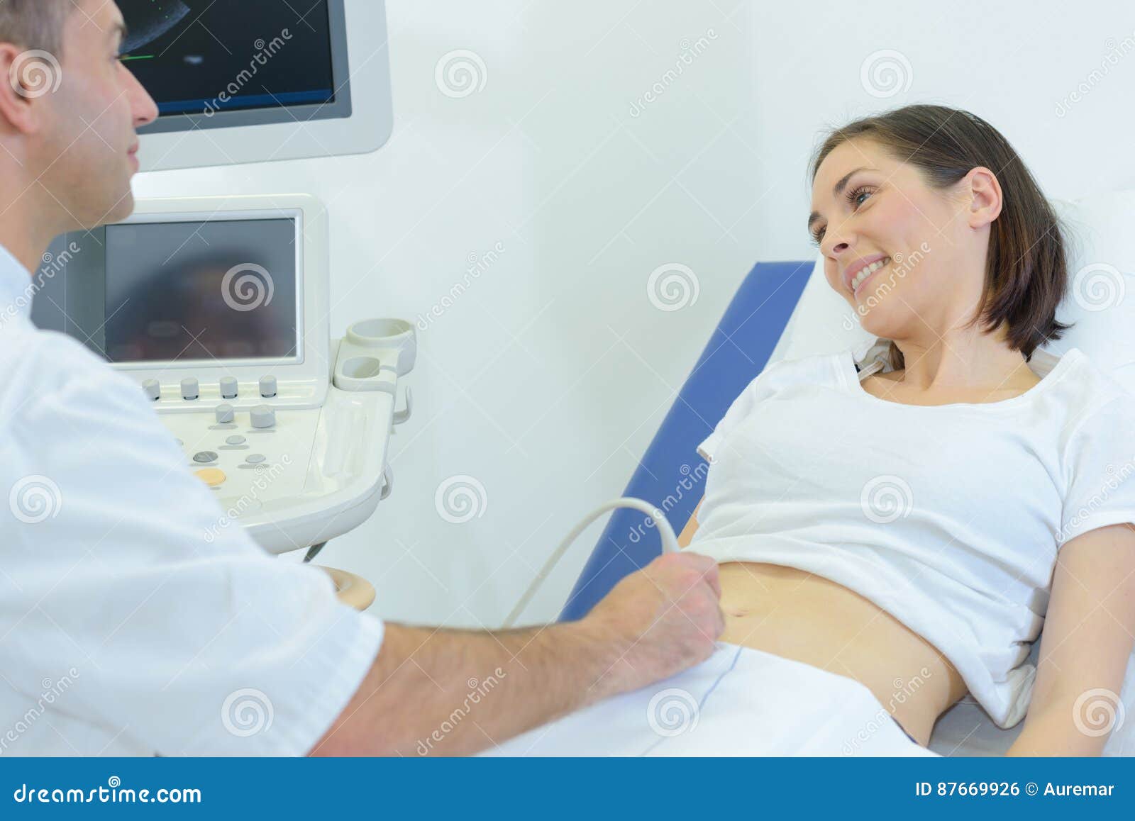 Woman having scan abdomen stock photo. Image of smile - 87669926