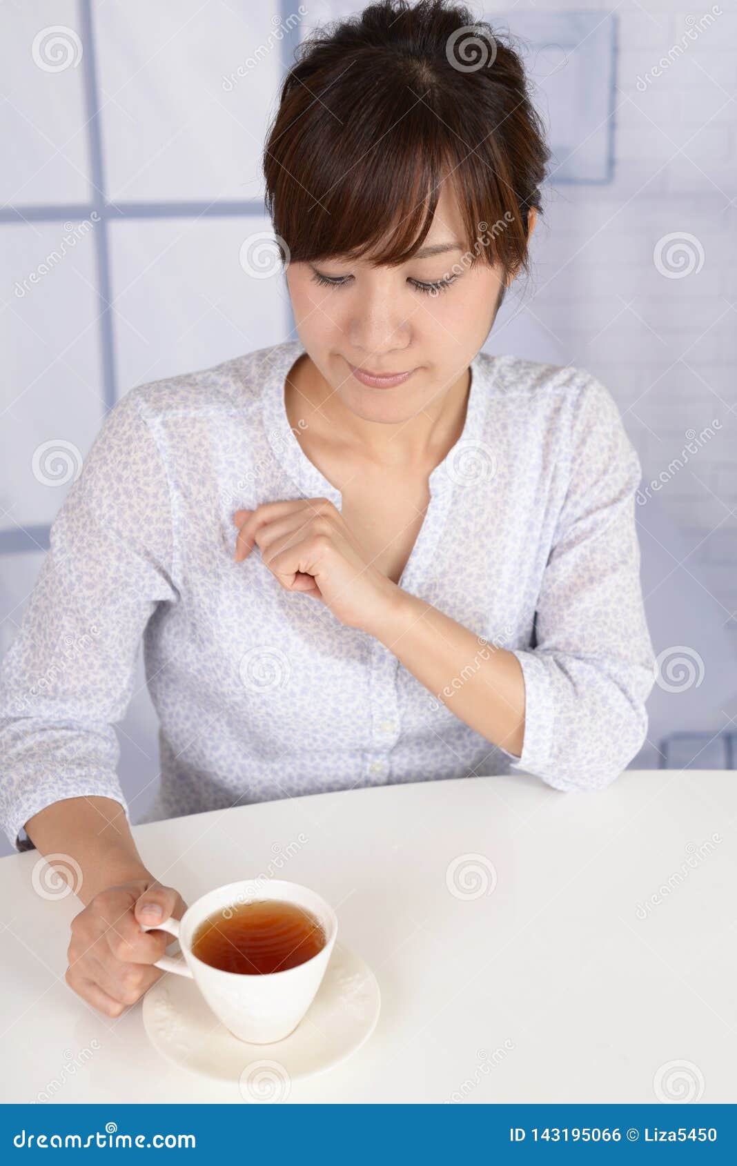 Woman having tea stock photo. Image of drink, home, expression - 143195066