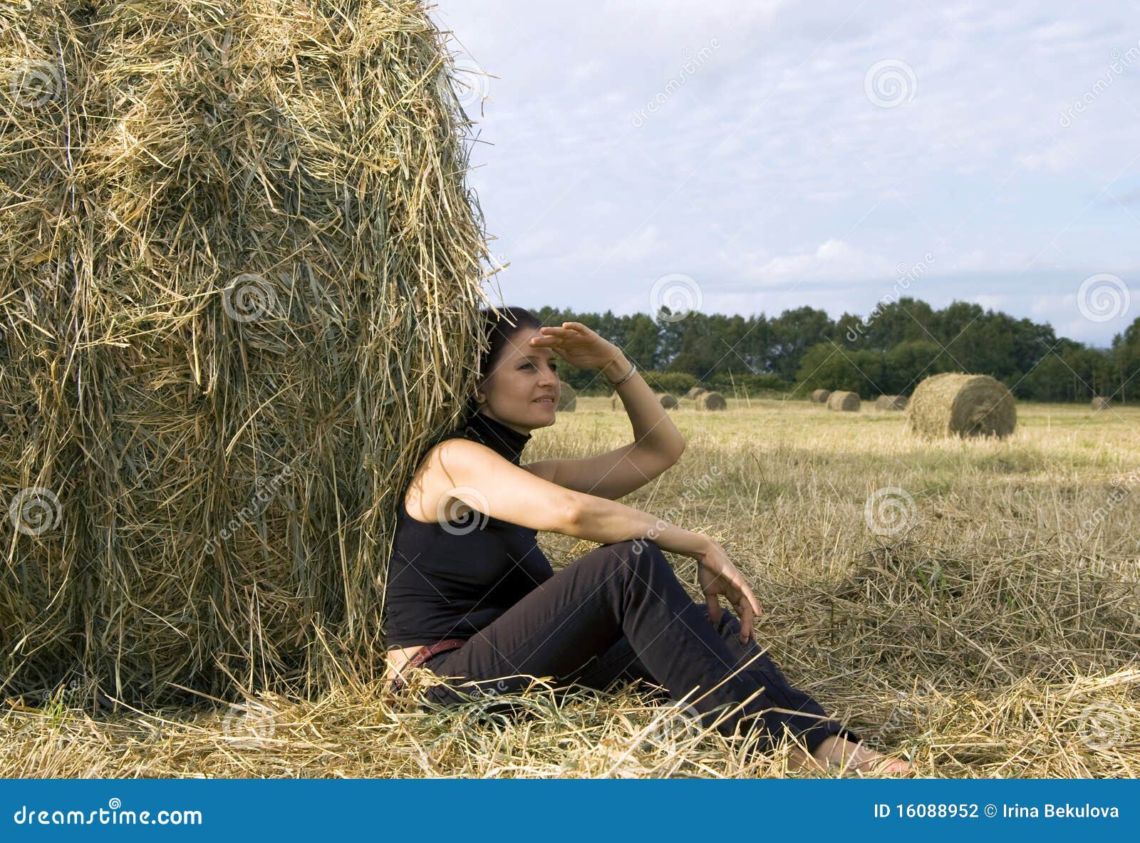 Woman about a haystack stock photo. Image of outdoors - 16088952