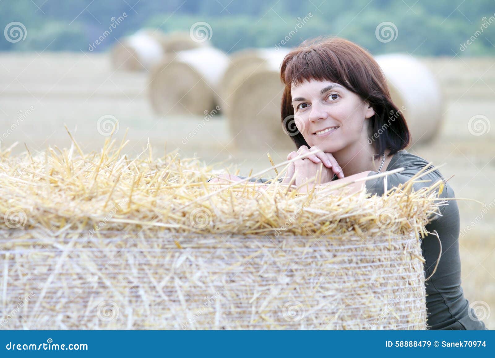 Woman on the haystack stock image. Image of summer, horizon - 58888479