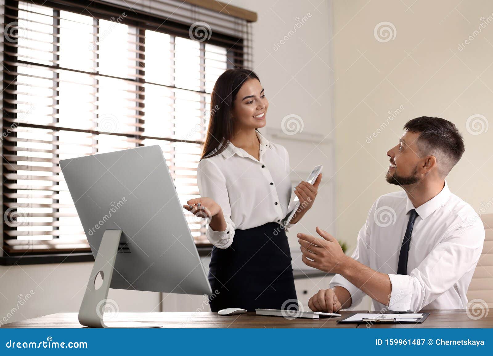 Woman Helping Her Colleague with Work Stock Image - Image of ...
