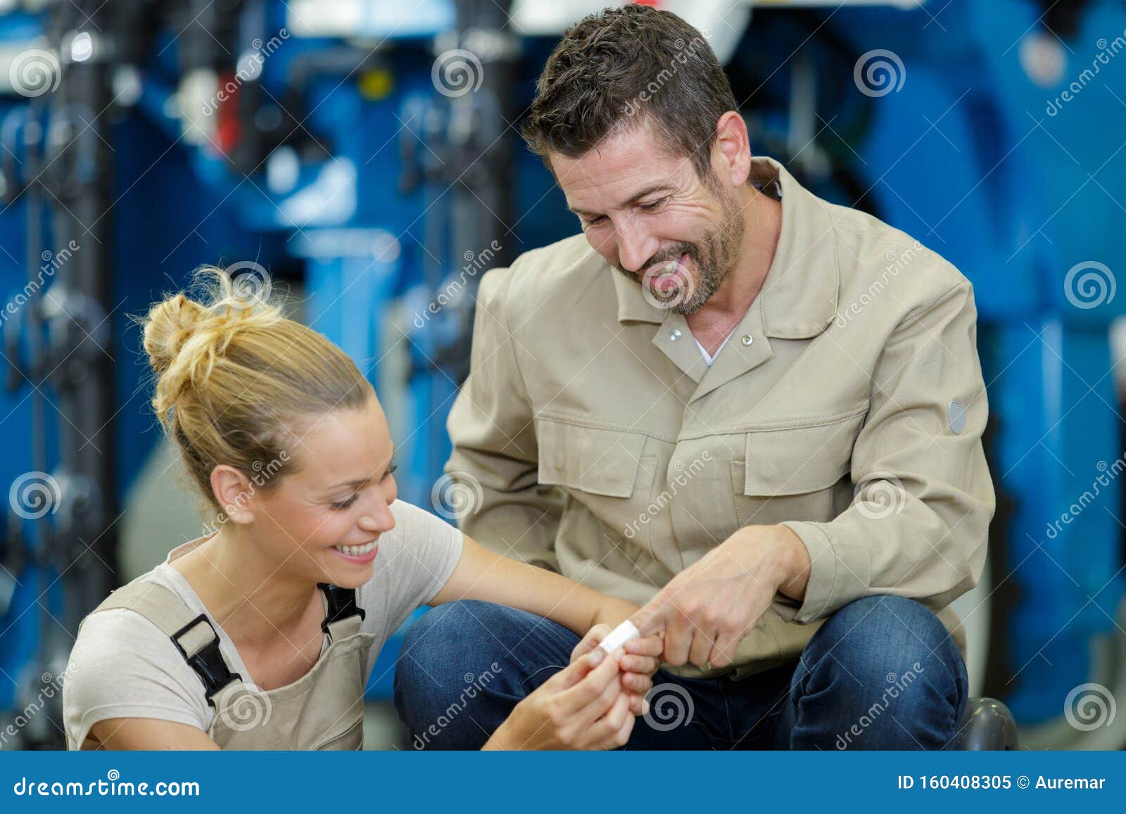 Woman helping injured man stock image. Image of helmet - 160408305