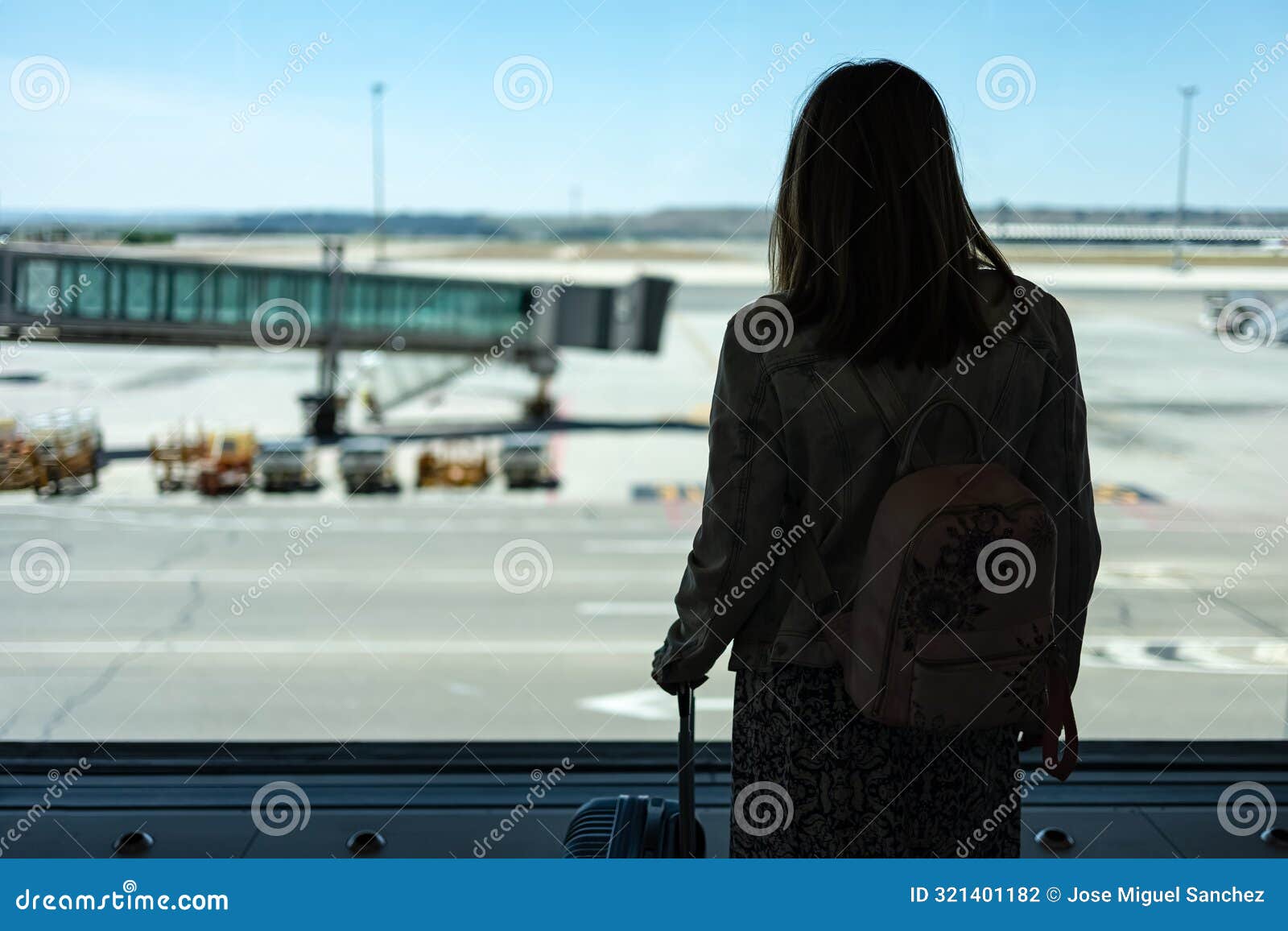 Woman with Her Back Turned Looking Out the Window while Waiting To ...