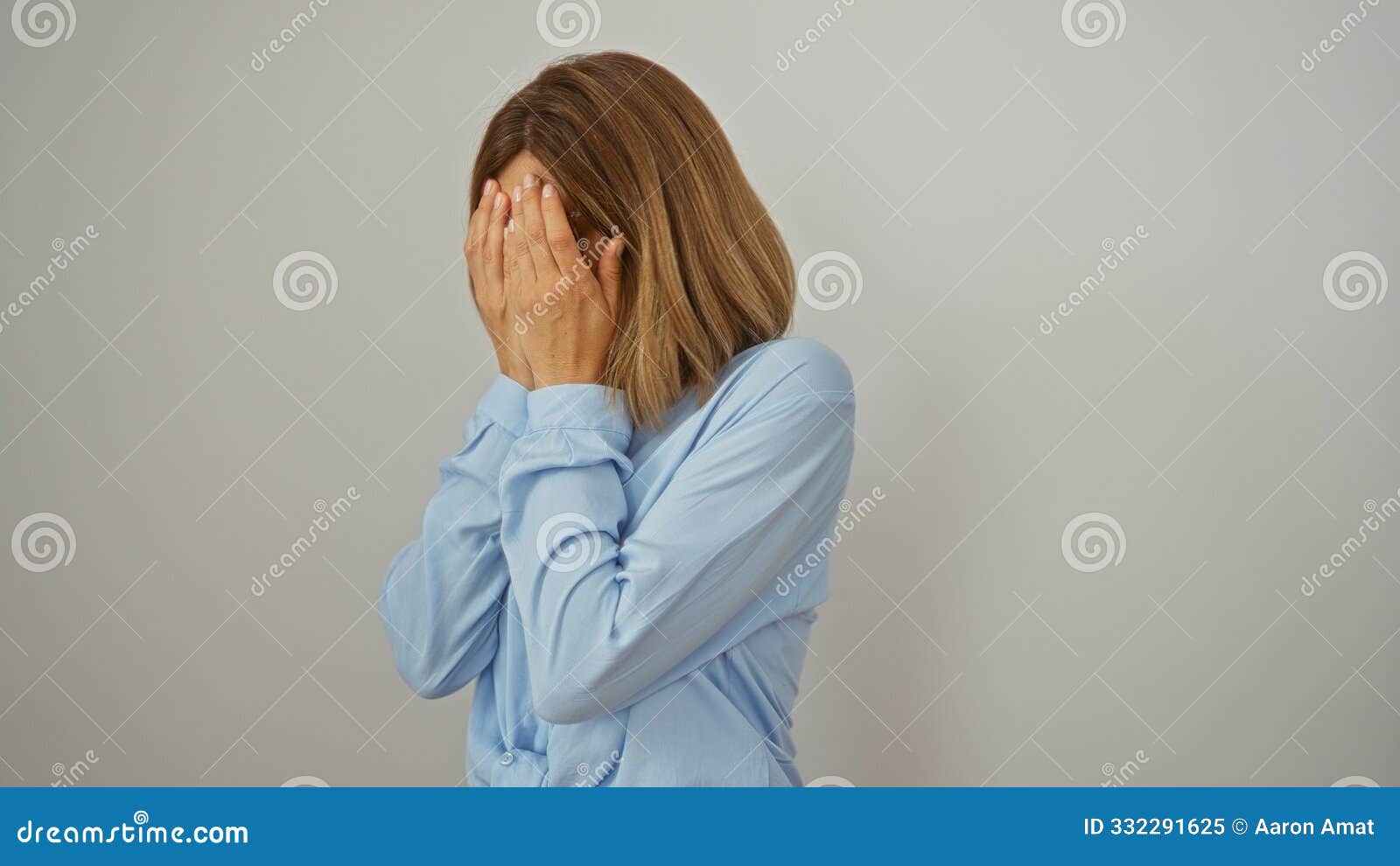 Woman Hiding Face with Hands Against a White Background, Displaying a ...