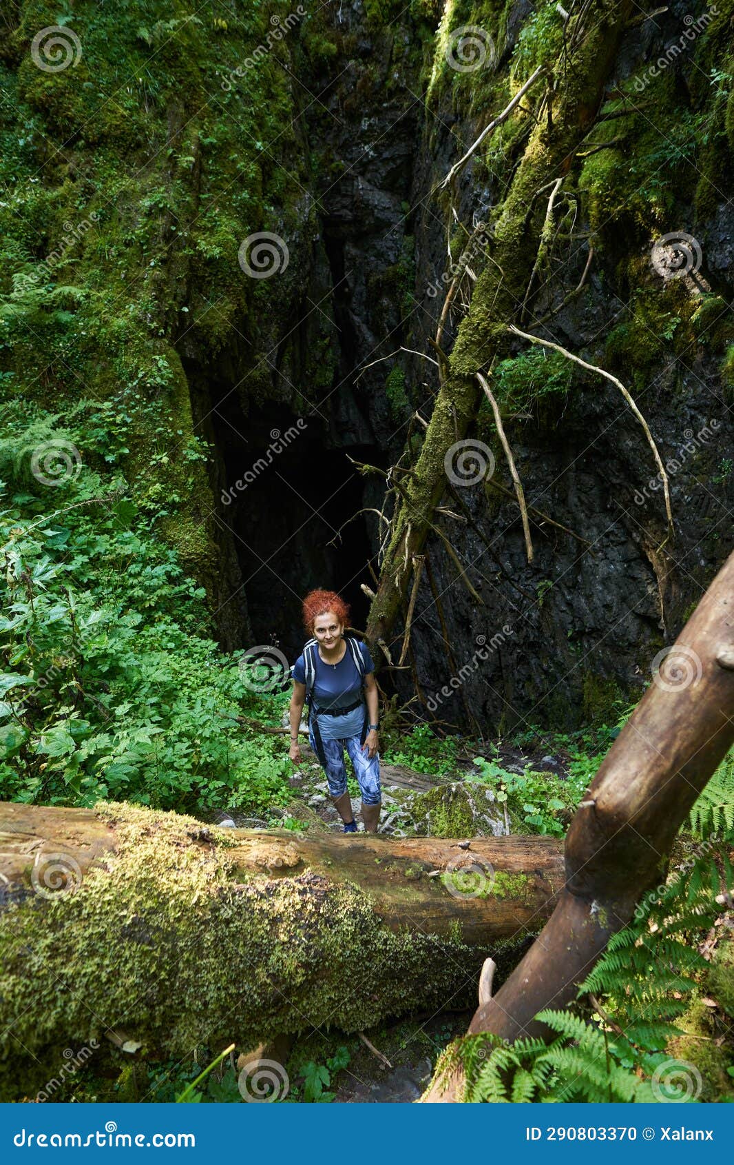 Woman exploring a cave stock photo. Image of hiking - 290803370
