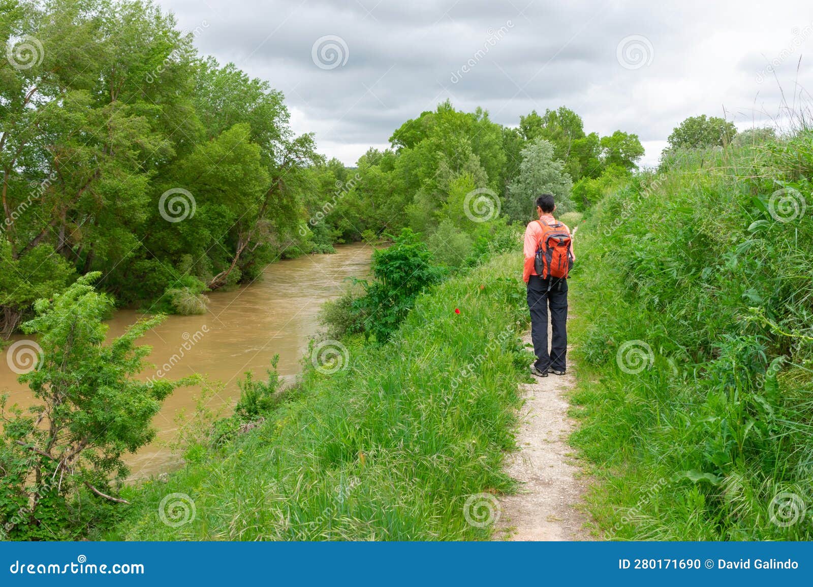 Woman Hiker with Backpack on the Path by the River Stock Photo - Image ...
