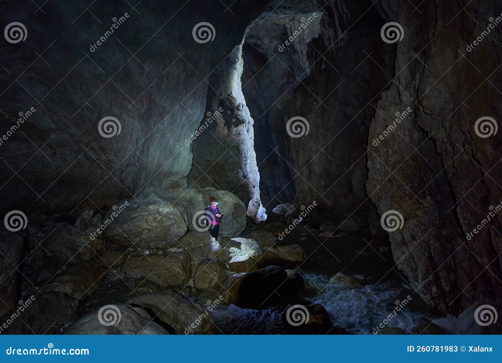 Woman hiking into a cave stock image. Image of backpack - 260781983