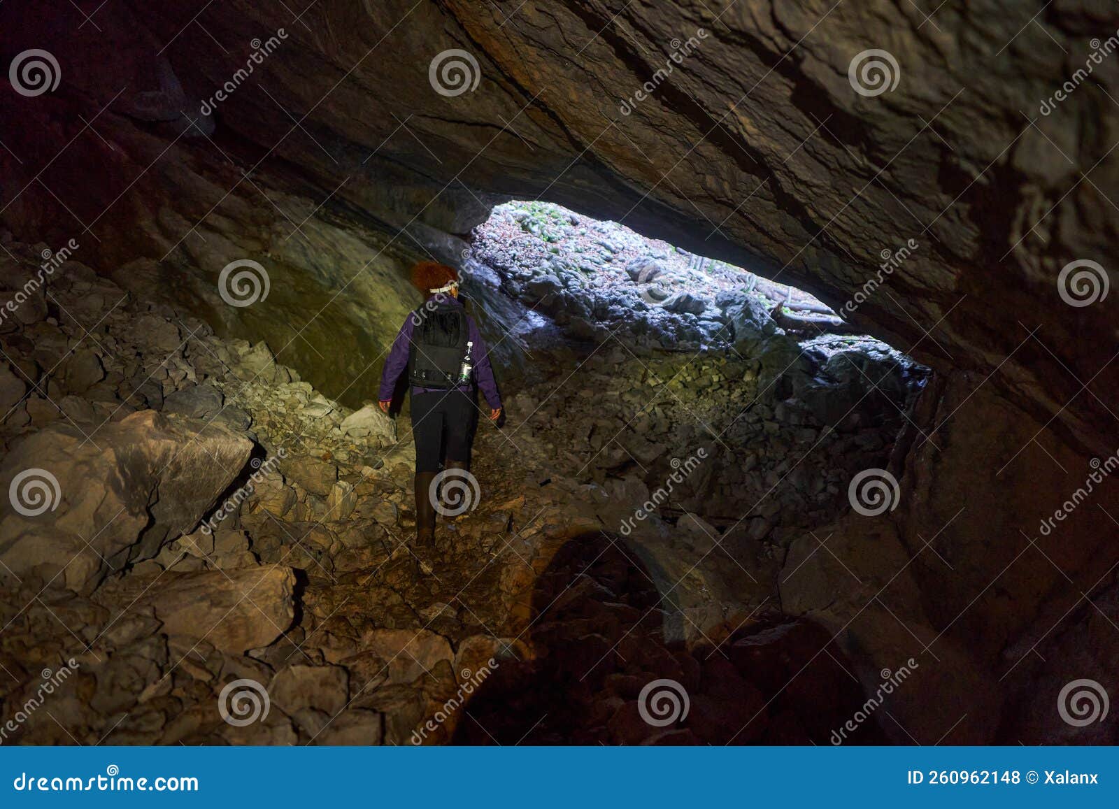 Woman hiking in a cave stock photo. Image of photographer - 260962148