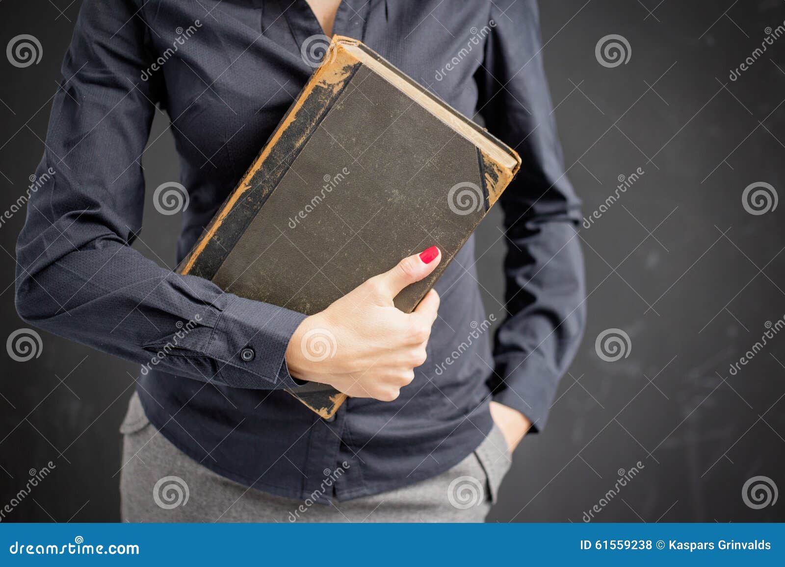 Woman holding closed book stock photo. Image of masters - 61559238