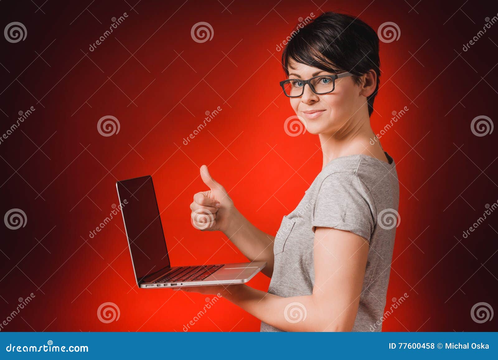 Woman Holding a Computer and Shows Thumb Stock Photo - Image of mature ...