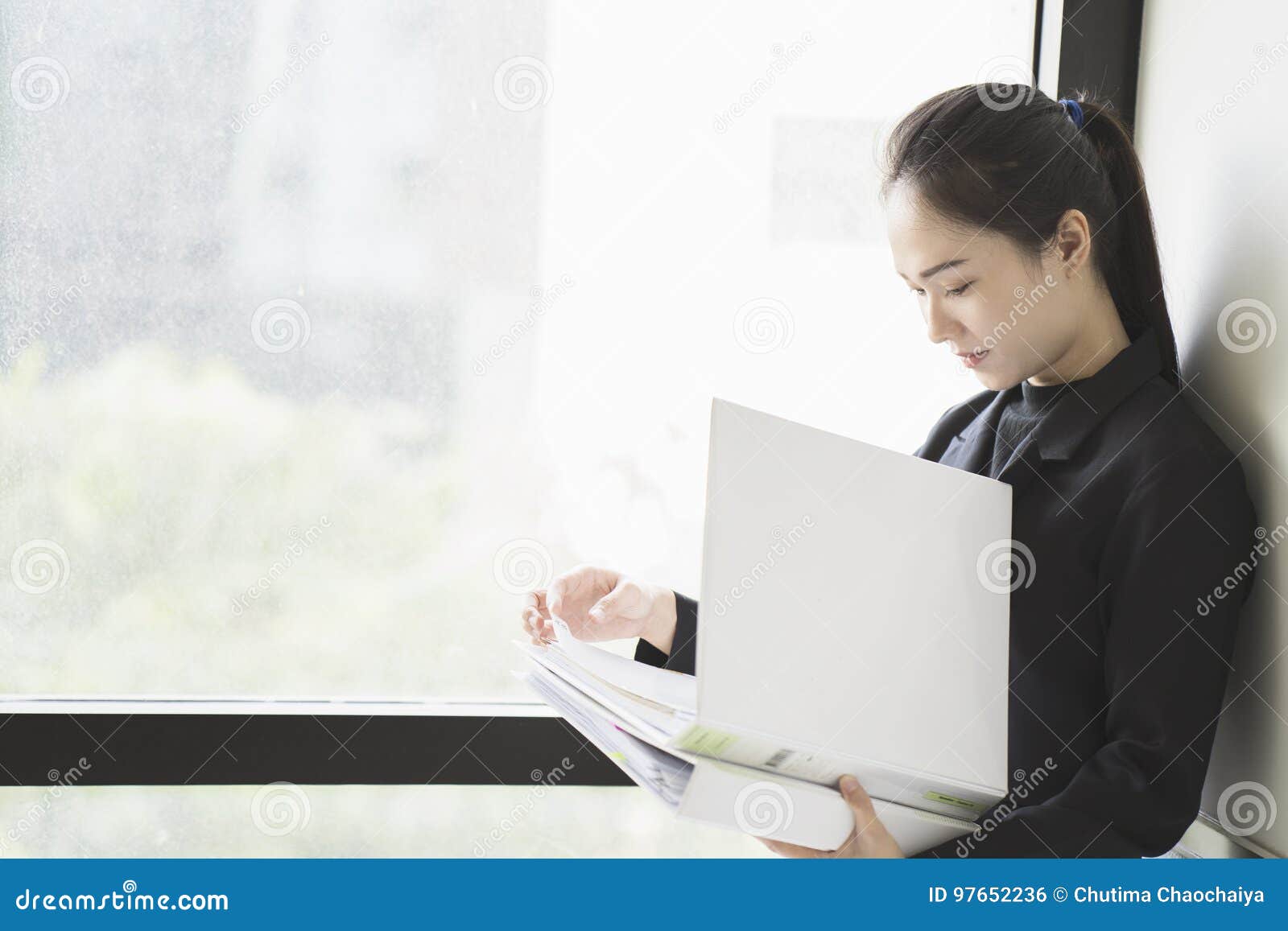 Woman Holding Document Files beside a Window Stock Photo - Image of ...