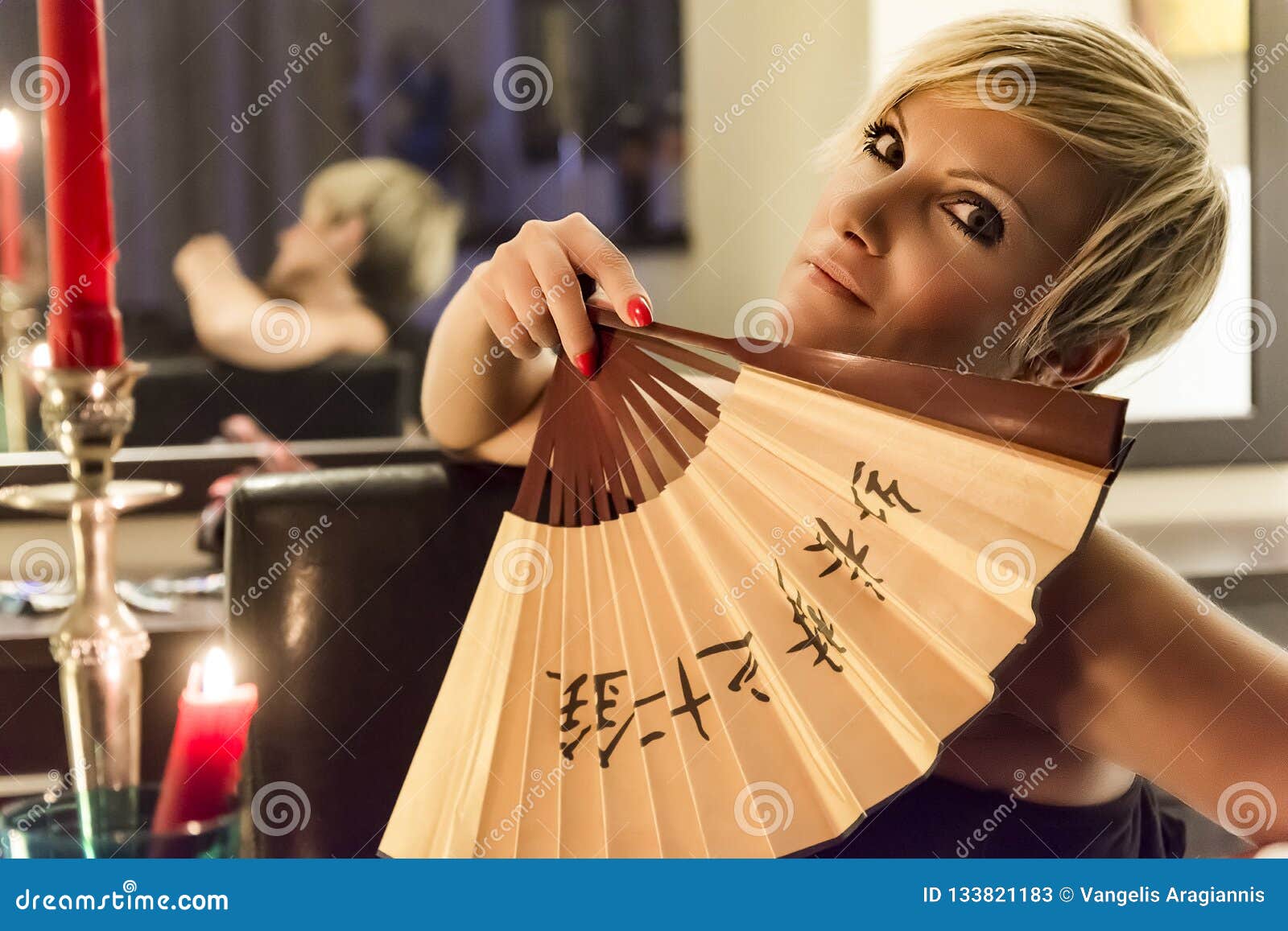 Woman is holding a fan stock image. Image of eyes, adult - 133821183