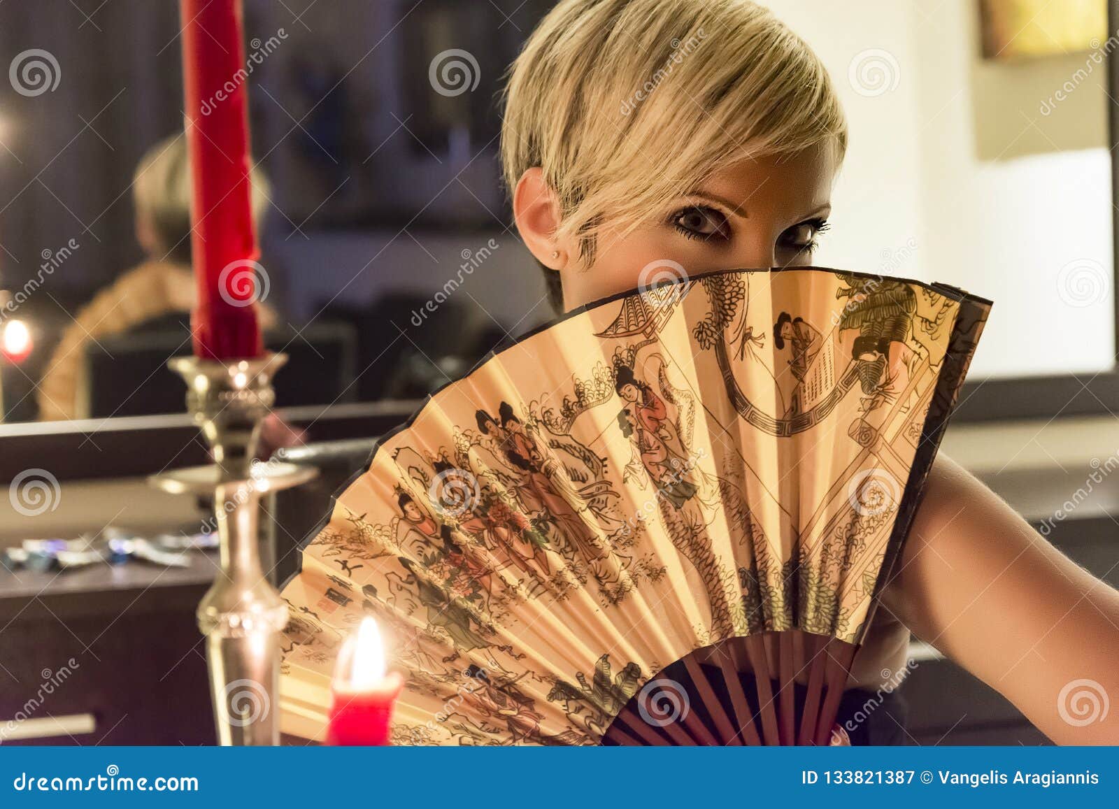 Woman is holding a fan stock image. Image of lifestyle - 133821387