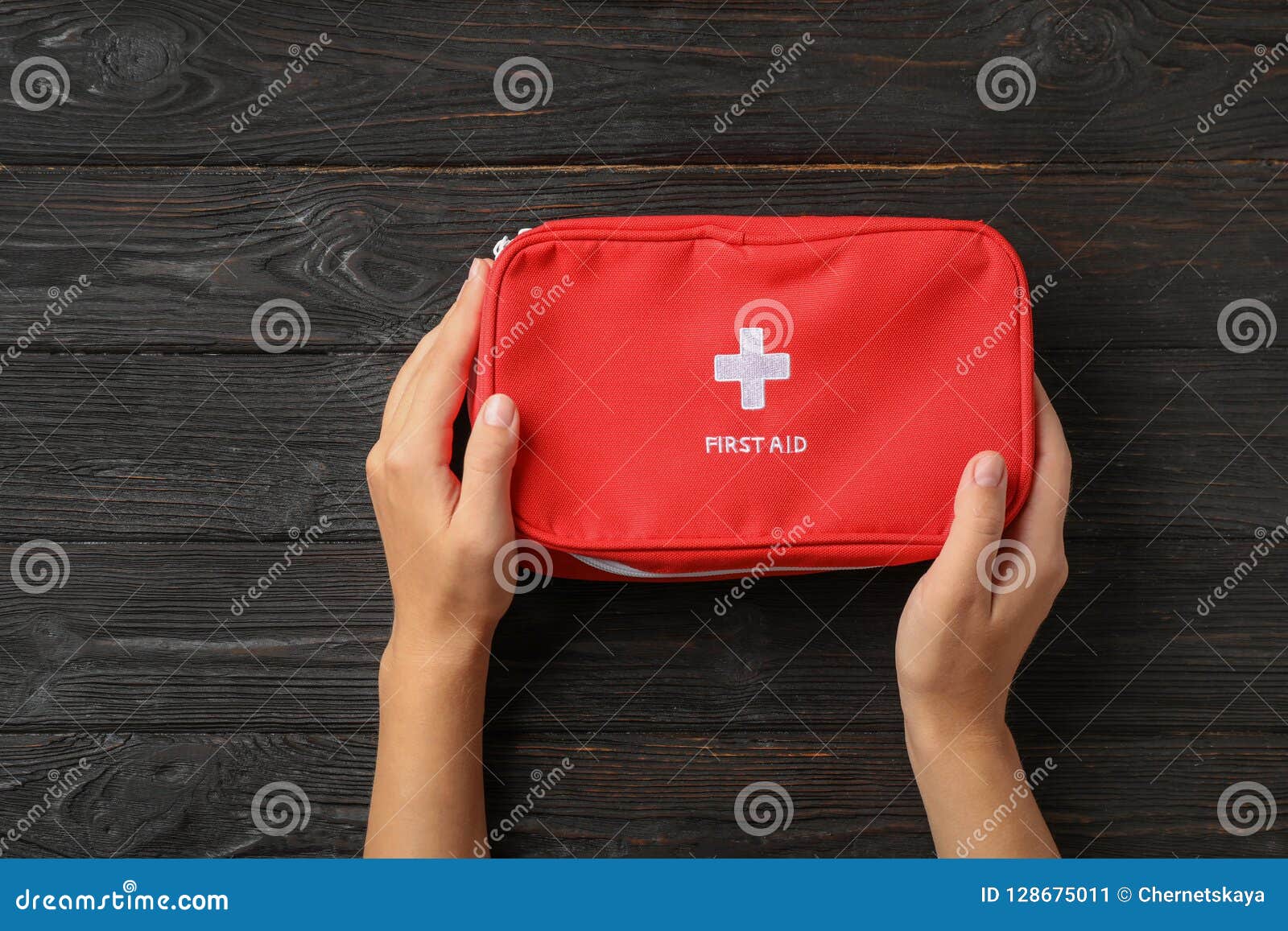 Woman Holding First Aid Kit on Dark Table Stock Image - Image of ...