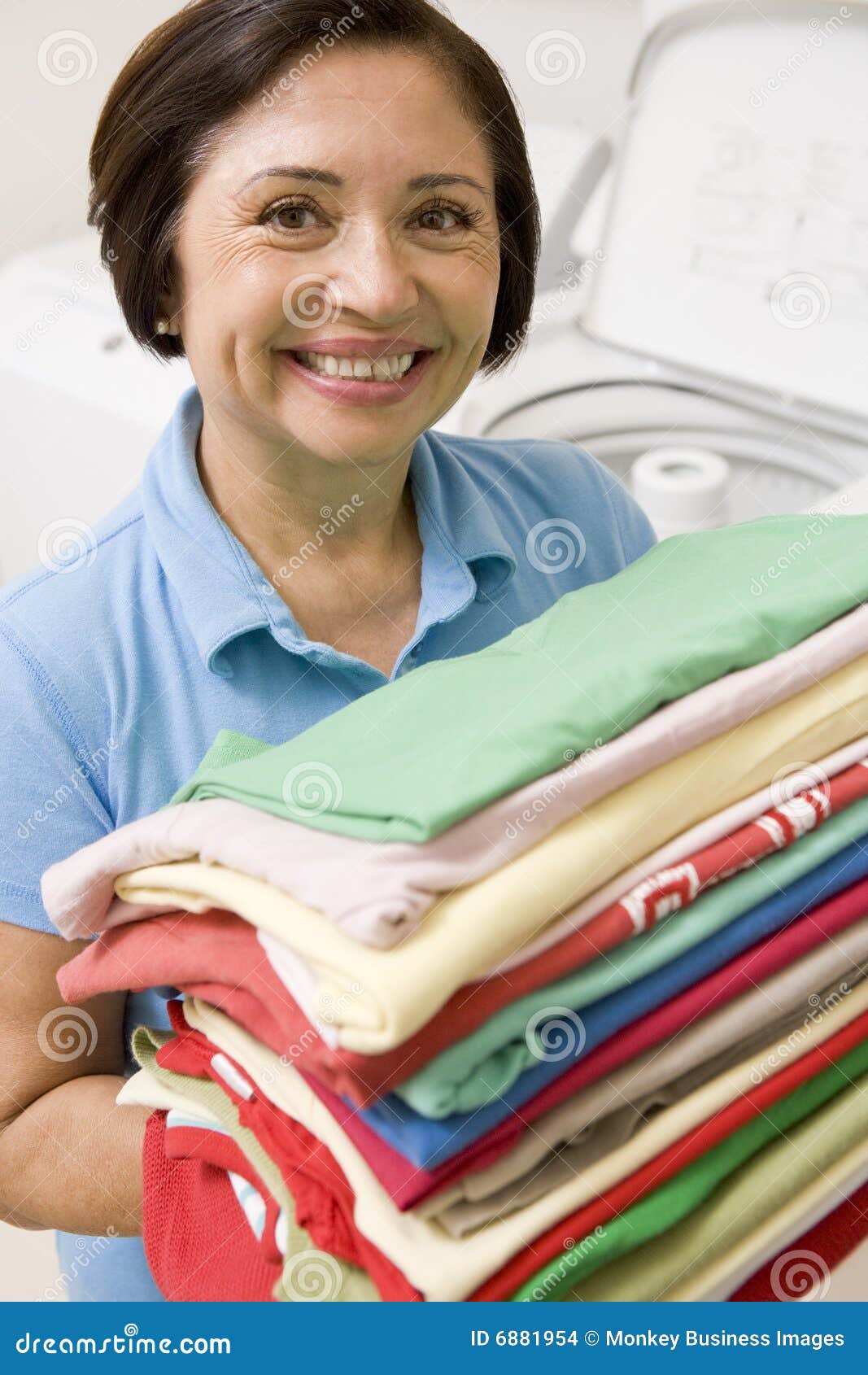 Woman Holding Folded Laundry Stock Photo - Image of looking, domestic ...