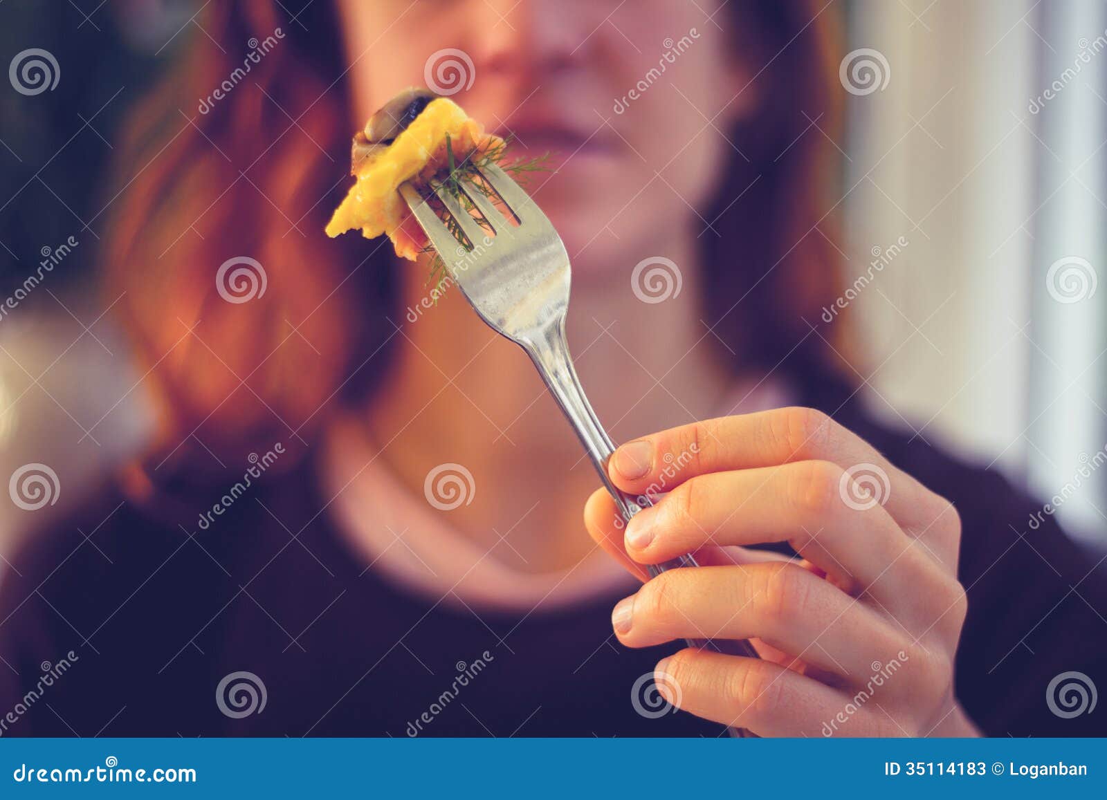 Woman Holding a Fork with Food Up in Front of Her Face Stock Image ...