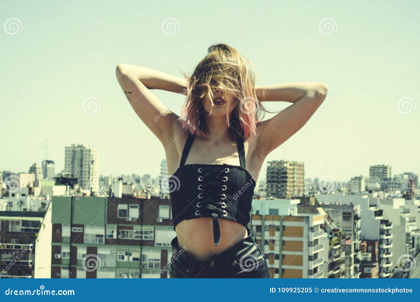 Woman Holding Her Head Wearing Black Sleeveless Crop Top Picture Image