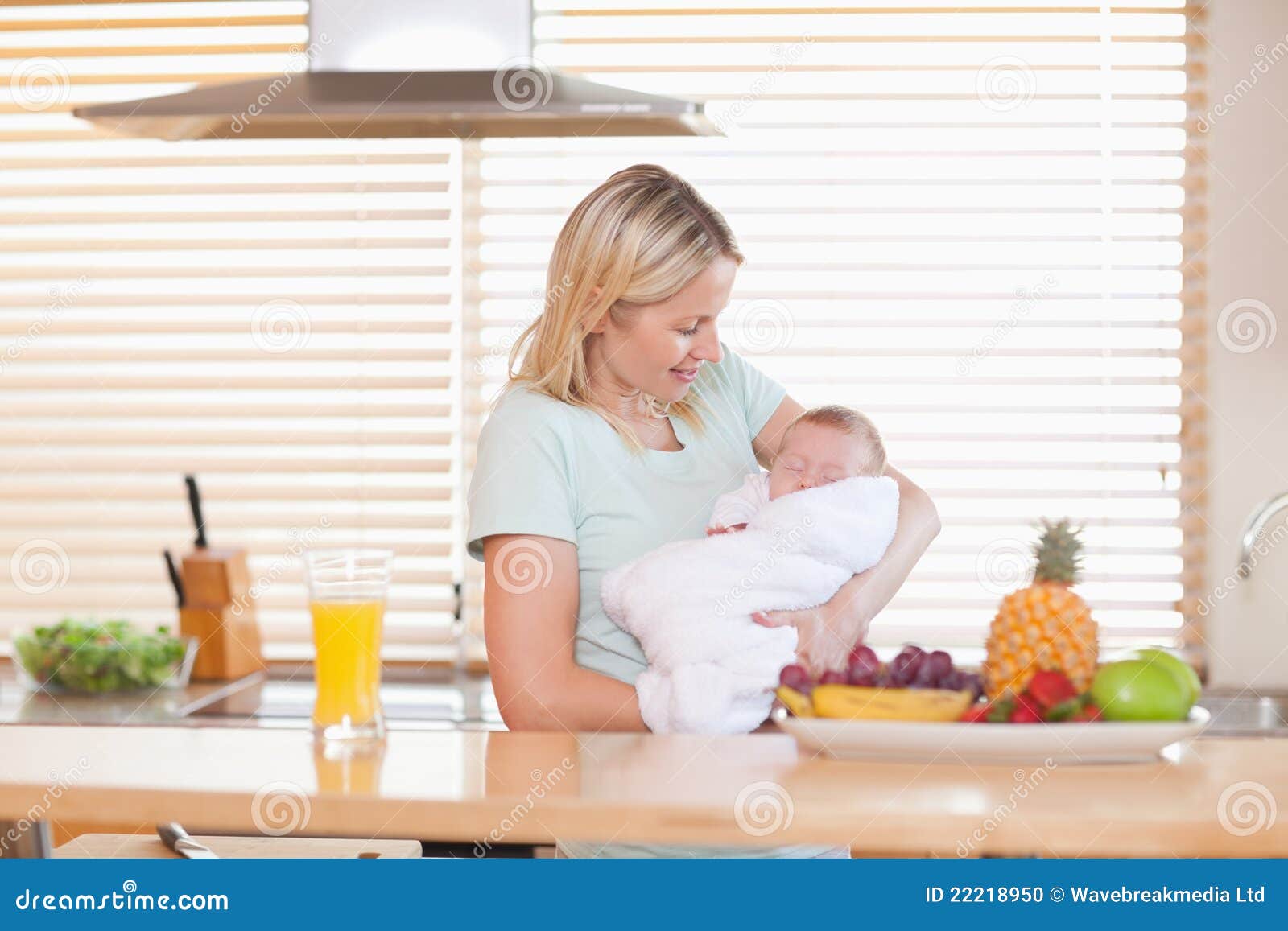Woman Holding Her Sleeping Baby in the Kitchen Stock Photo - Image of ...